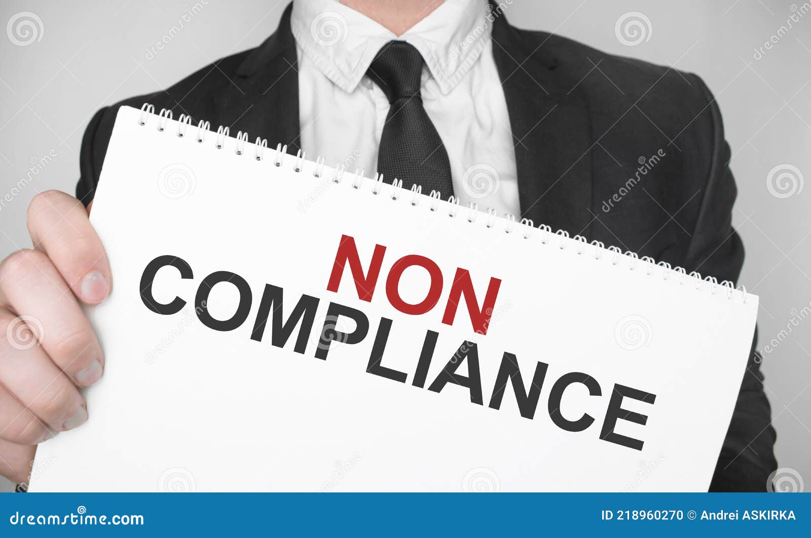 Businessman Holding a Card with Text NON COMPLIANCE Stock Photo - Image ...