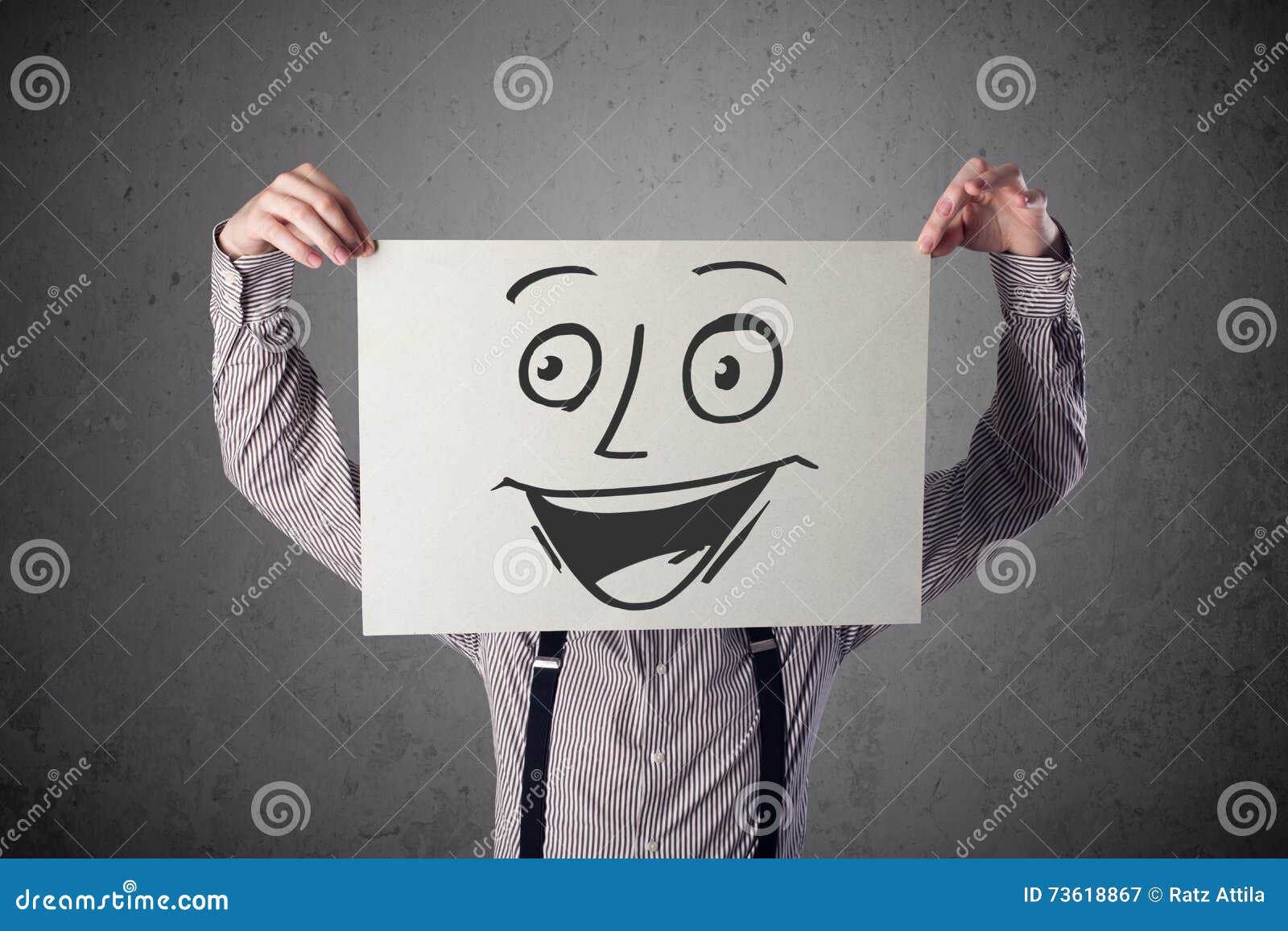 Businessman Holding a Cardboard with Smiley Face on it in Front Stock ...