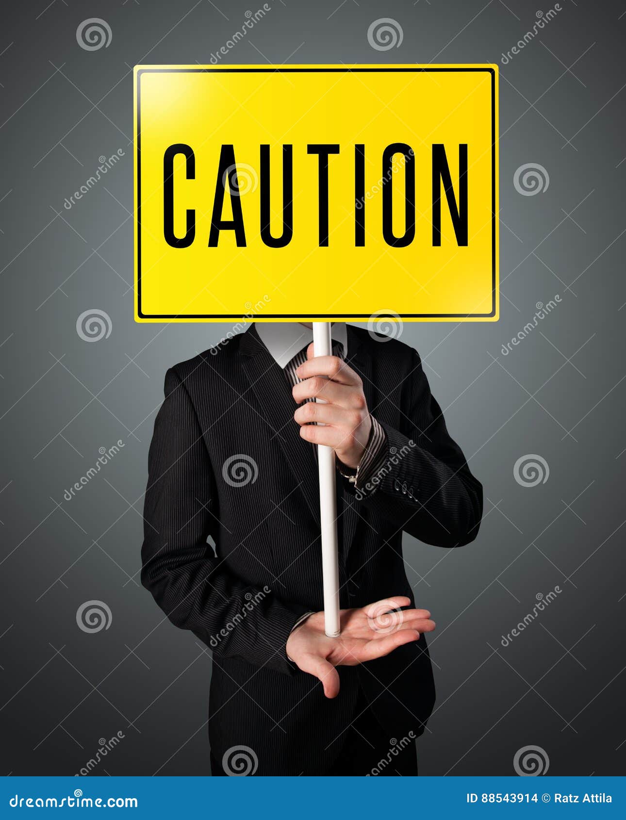 Businessman Holding a Caution Sign Stock Photo - Image of hide, hazard ...