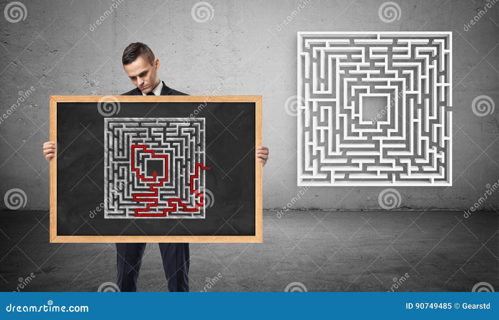 A Businessman Holding a Chalkboard with a Picture of a Solved Maze ... A Businessman Holding a Chalkboard with a Picture of a Solved Maze ...