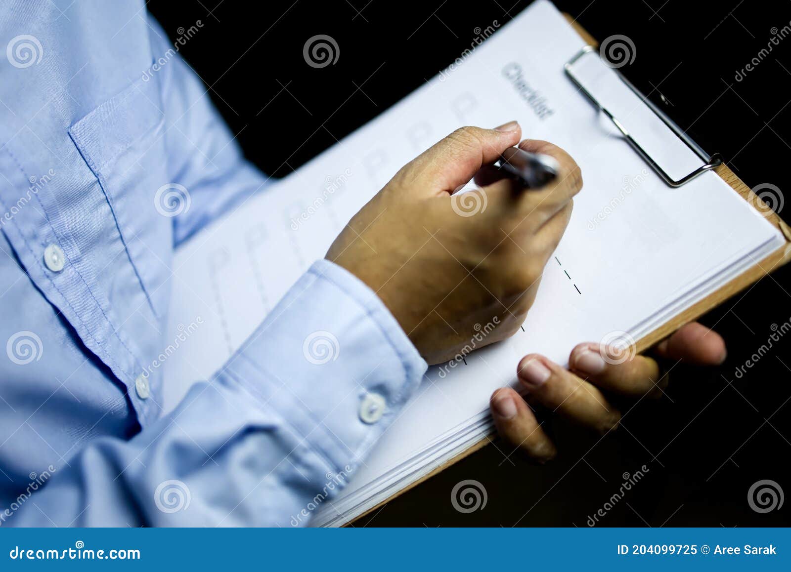 Businessman Holding a Clipboard and Writing the Check List after Stock ... Businessman Holding a Clipboard and Writing the Check List after Stock ...
