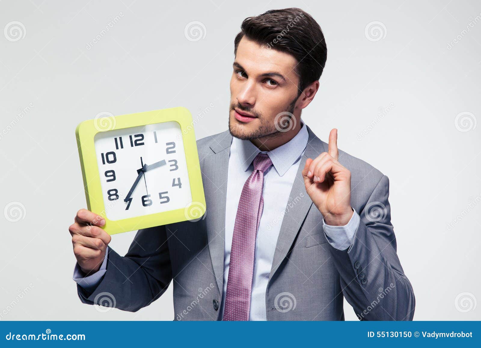 Businessman holding clock stock photo. Image of attire - 55130150