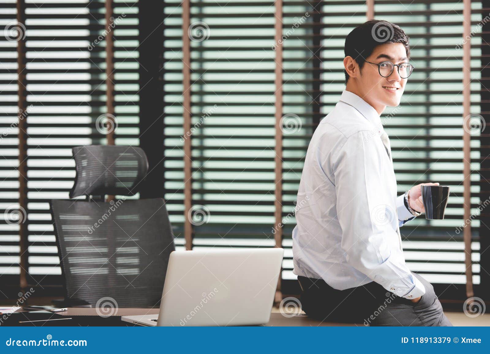 Businessman Holding Cup of Coffee Sitting on Desk in Office Stock Image ... Businessman Holding Cup of Coffee Sitting on Desk in Office Stock Image ...