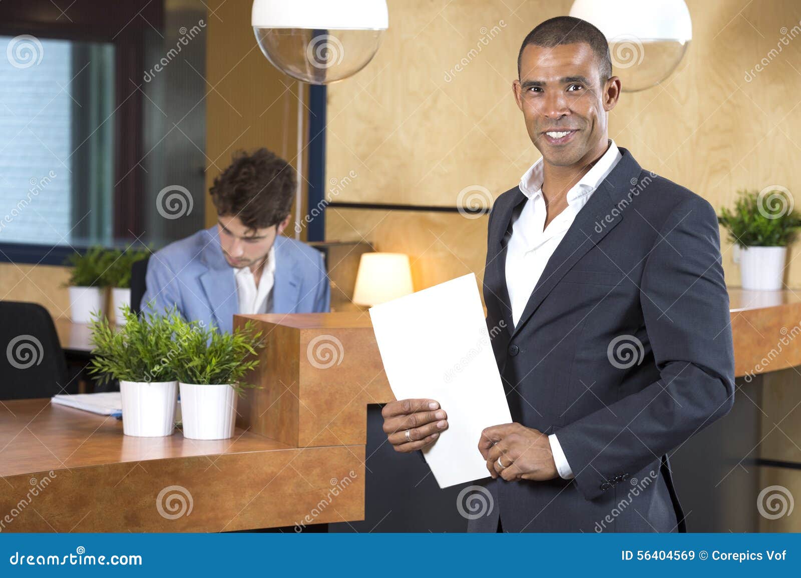Businessman Holding Documents at Reception Counter Stock Image - Image ...