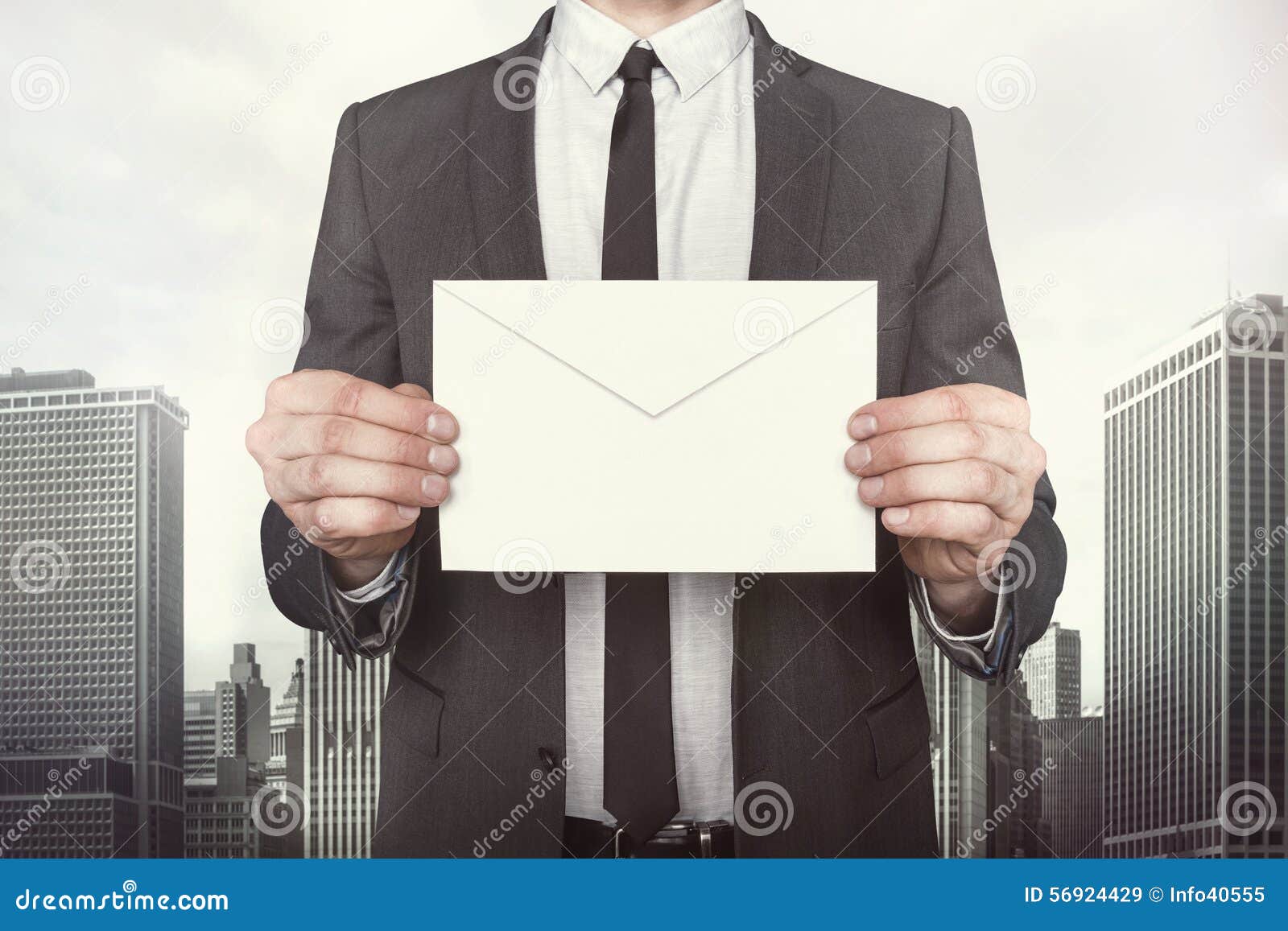 Businessman Holding Envelope Stock Image - Image of city, concept: 56924429