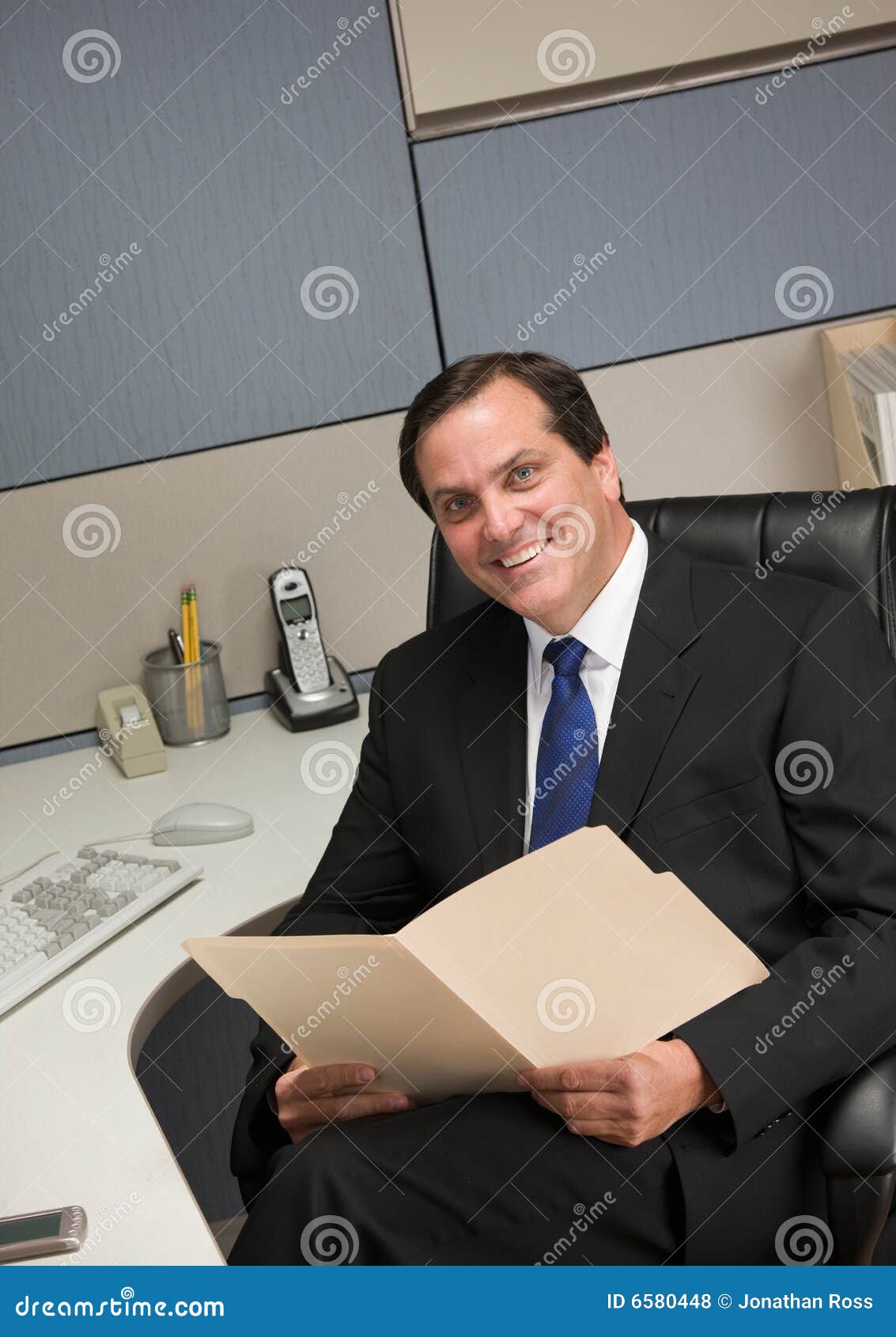Businessman Holding File Folder at Desk in Cubicle Stock Photo - Image ...