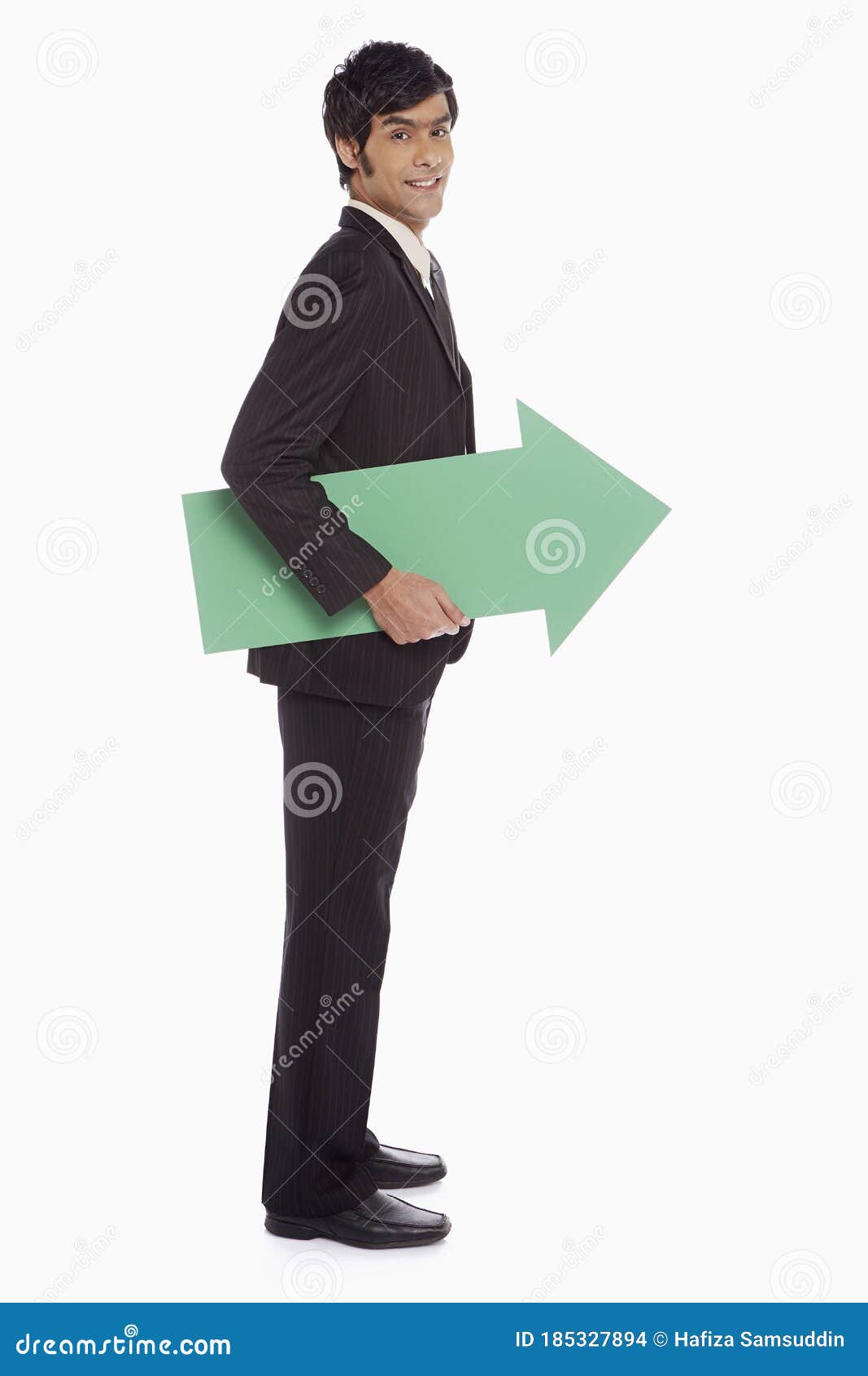 Businessman Holding a Green Arrow, Facing Left Stock Photo - Image of ...