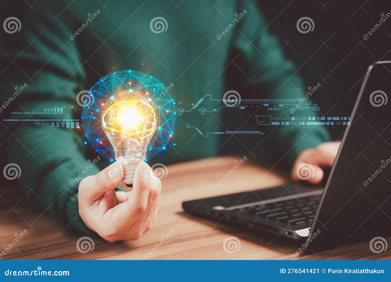 Businessman Holding a Light Bulb while Working on the Computer To Think ...