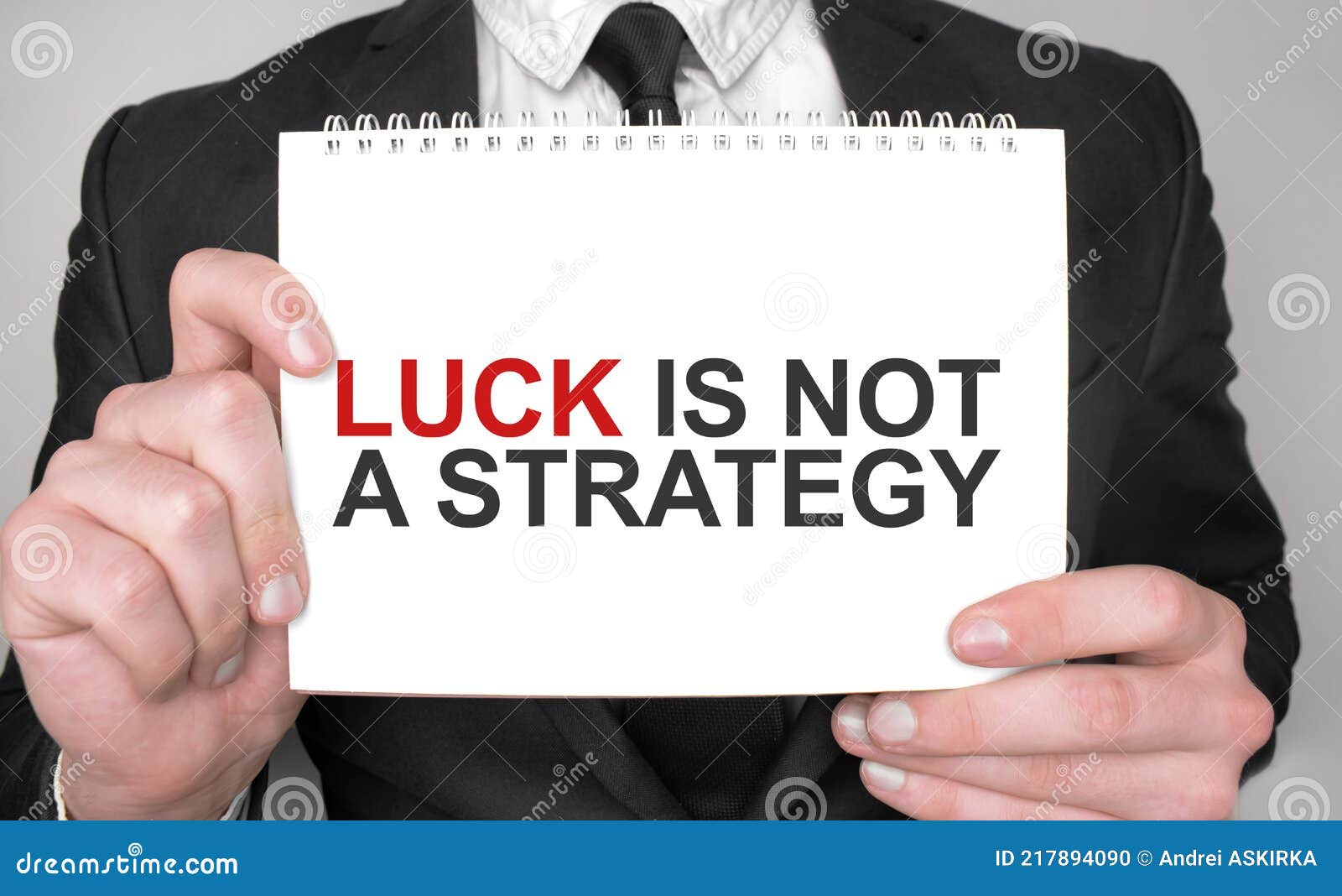 Businessman Holding a Notepad with Text Luck is Not a Strategy Stock ...