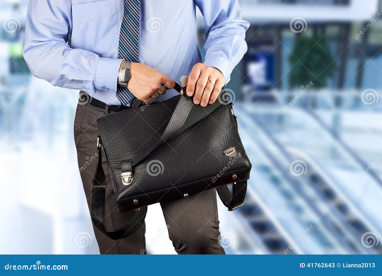 Businessman Holding and Opening a Leather Briefcase Stock Image - Image ...