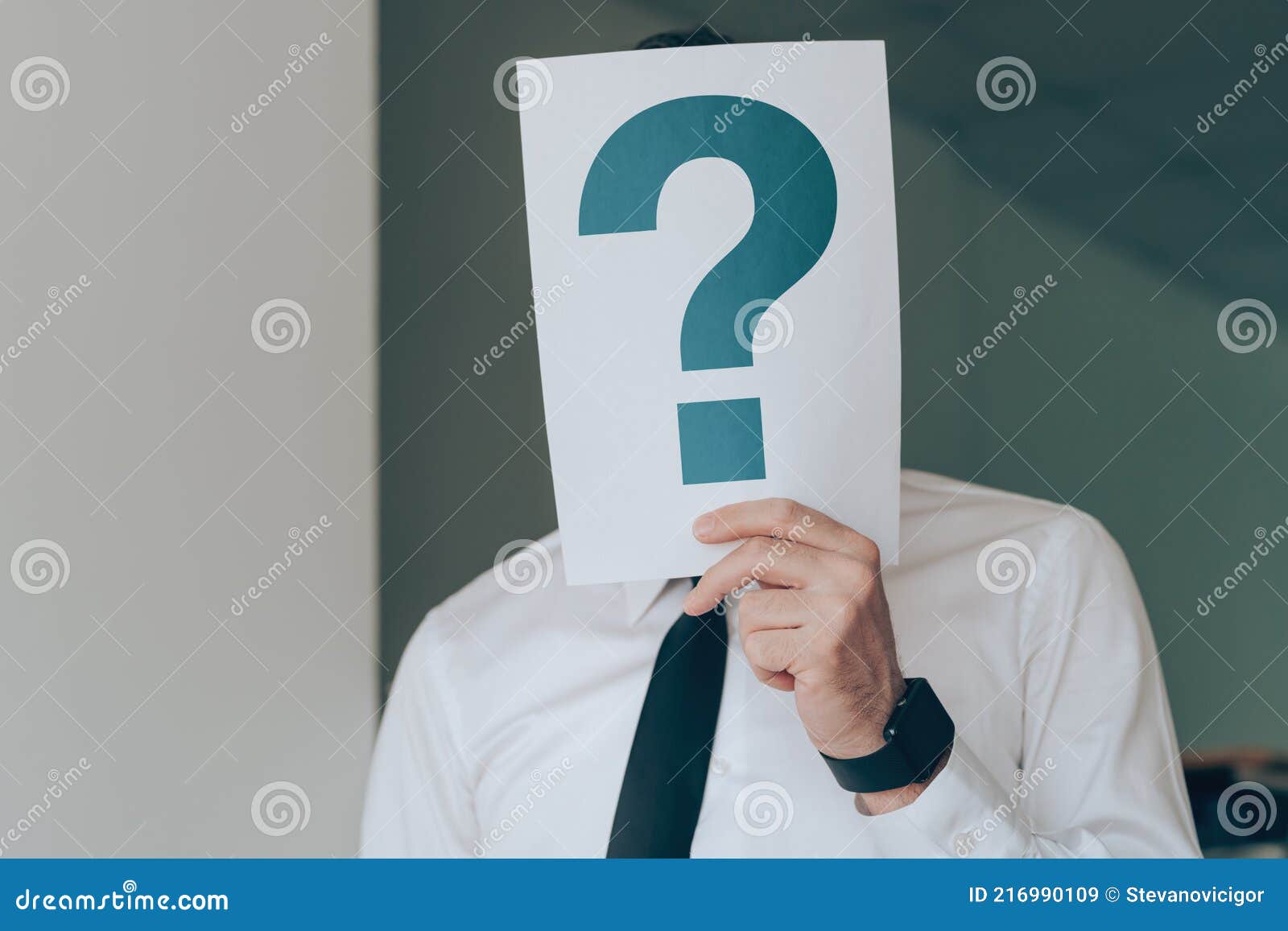 Businessman Holding Paper with Printed Question Mark Over His Face ...