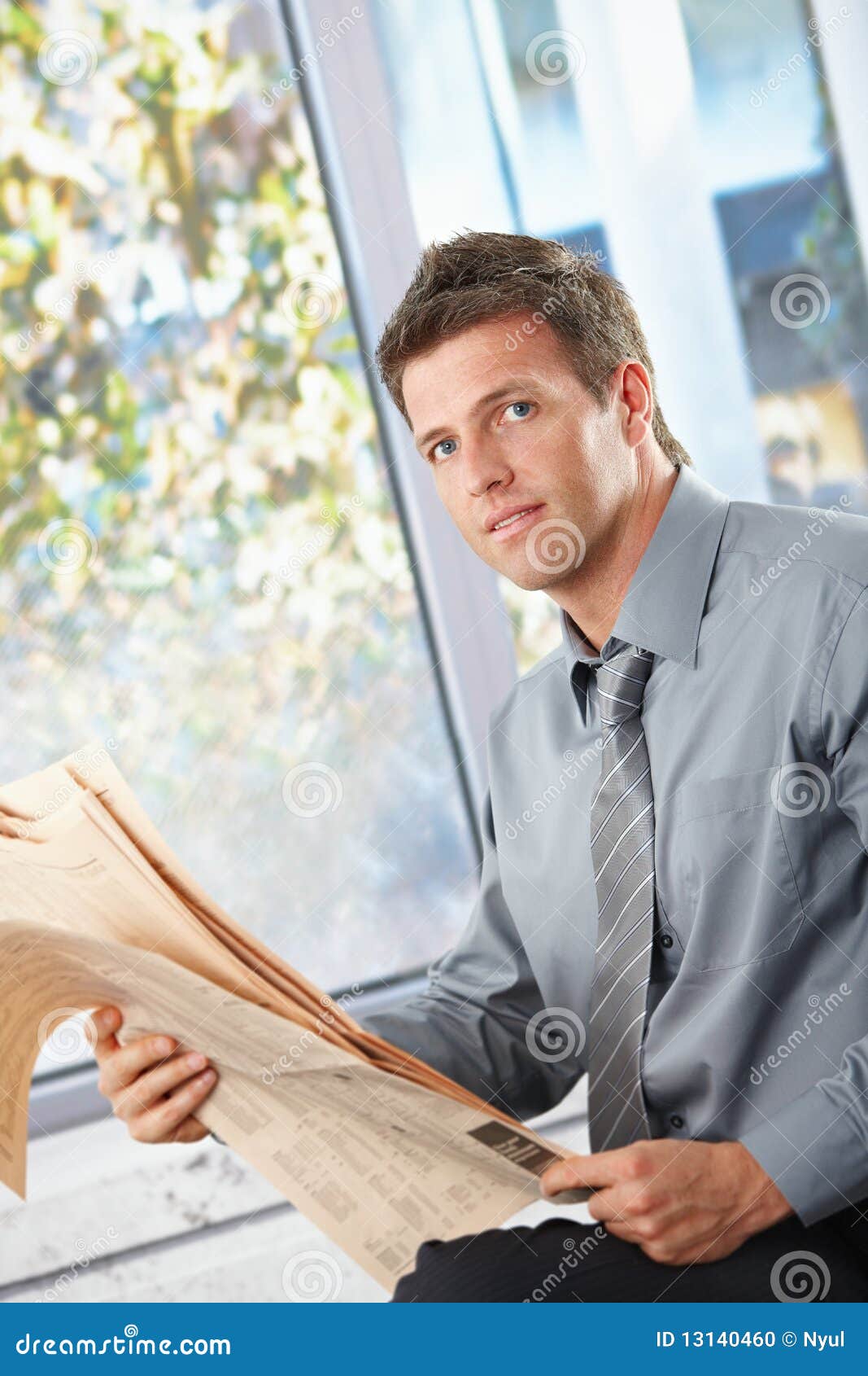 Businessman Holding Papers Looking at Camera Stock Photo - Image of ...