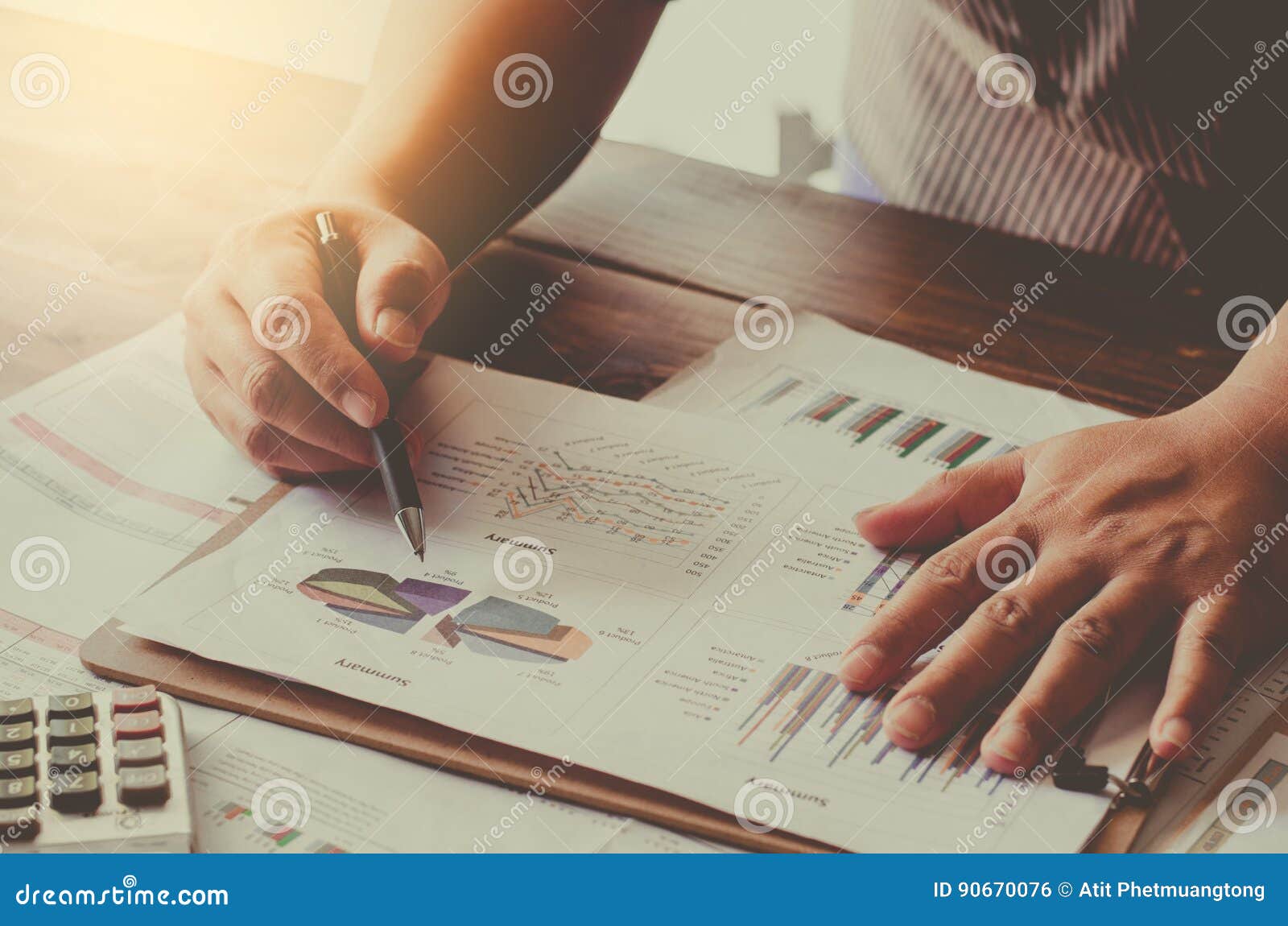 Businessman Holding Paperwork on the Table and Analyzing Stock Photo ...