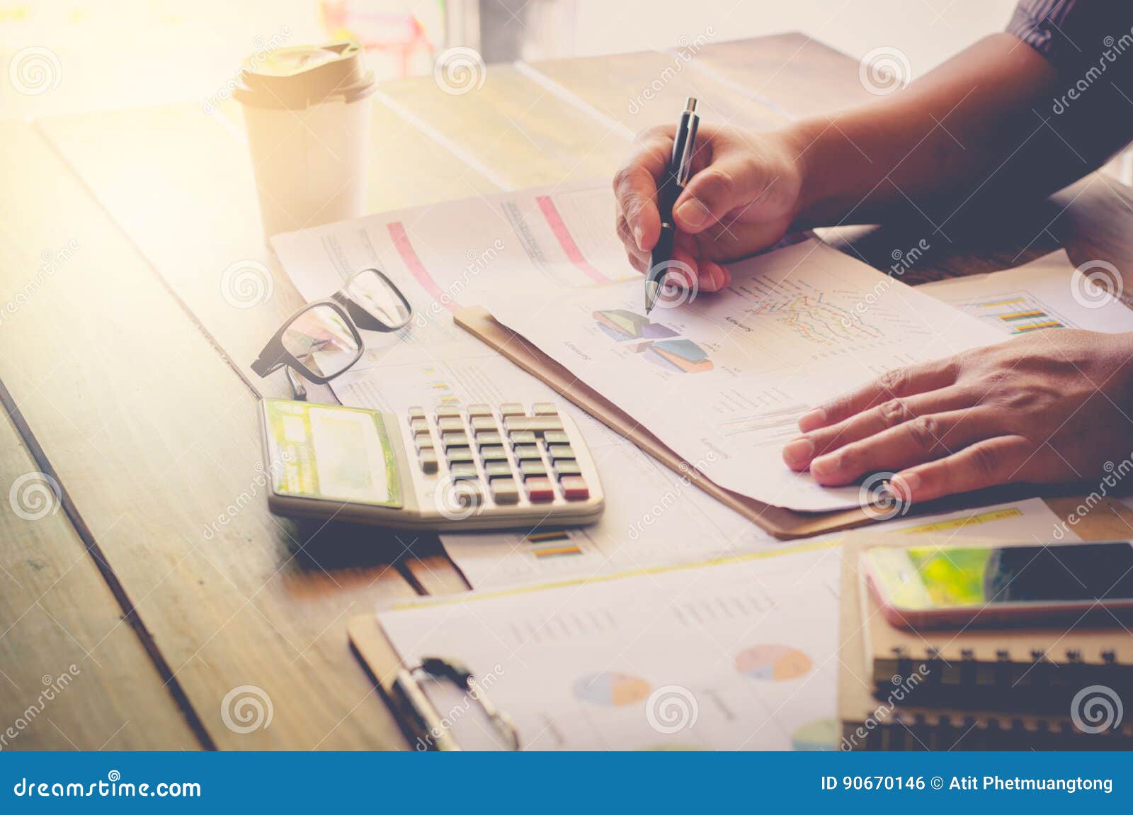 Businessman Holding Paperwork on the Table and Analyzing Stock Photo ...