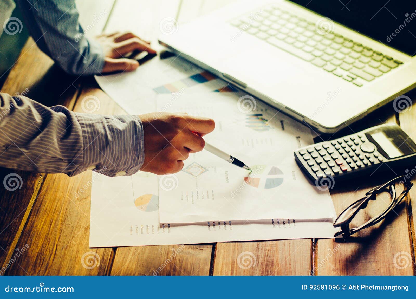 Businessman Holding Paperwork on the Table and Analyzing Stock Photo ...