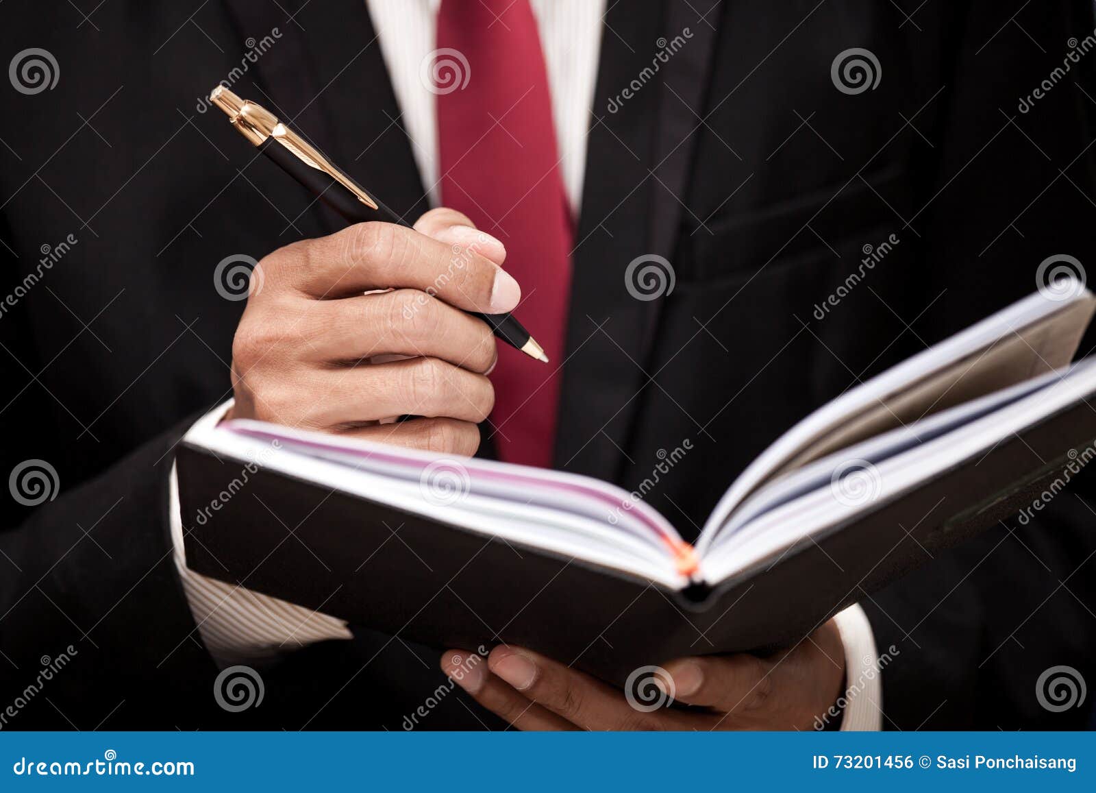 Businessman Holding a Pen To Write on Notebook Stock Photo - Image of ...