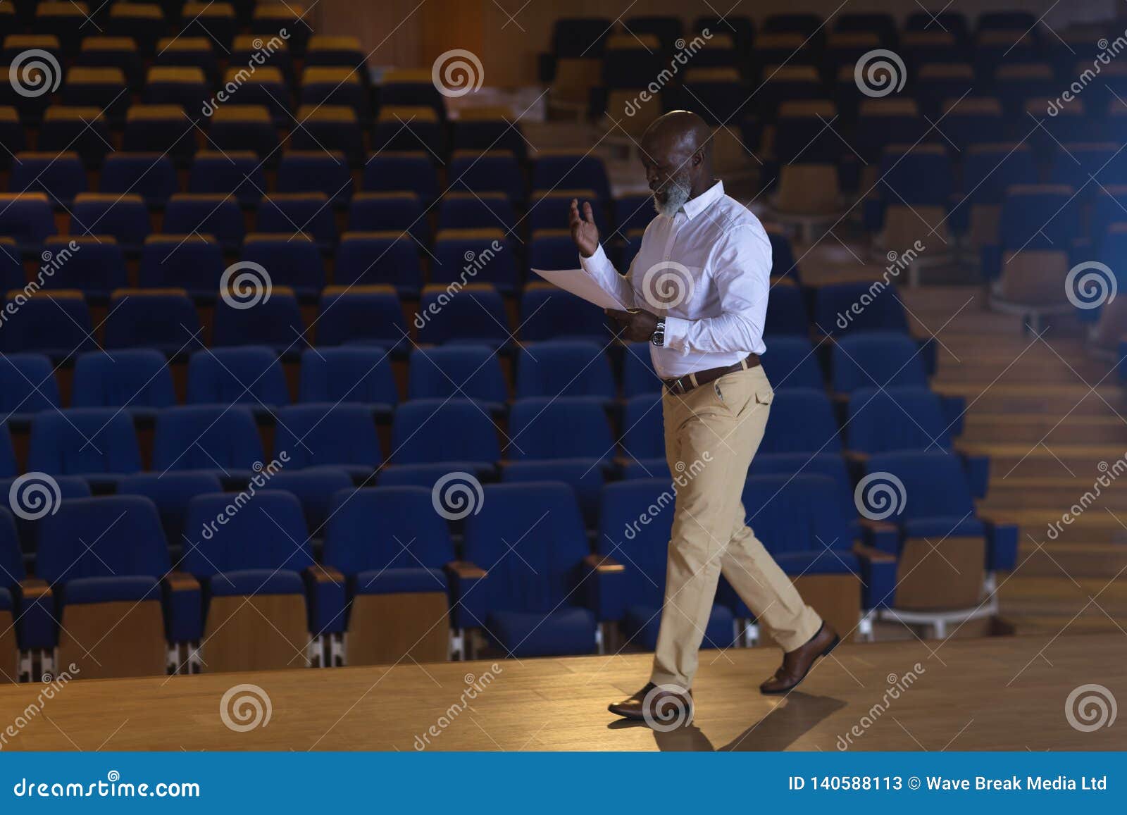 Businessman with Holding Script Walking in a Auditorium Stock Image ...