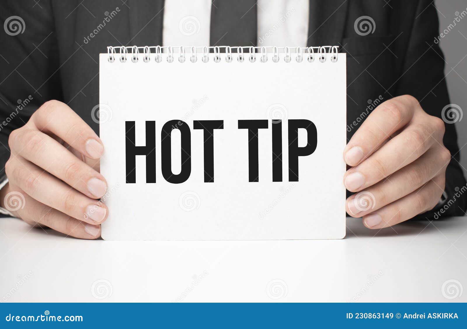 Businessman Holding Sheet of Paper with a Message Hot Tip Stock Image ...