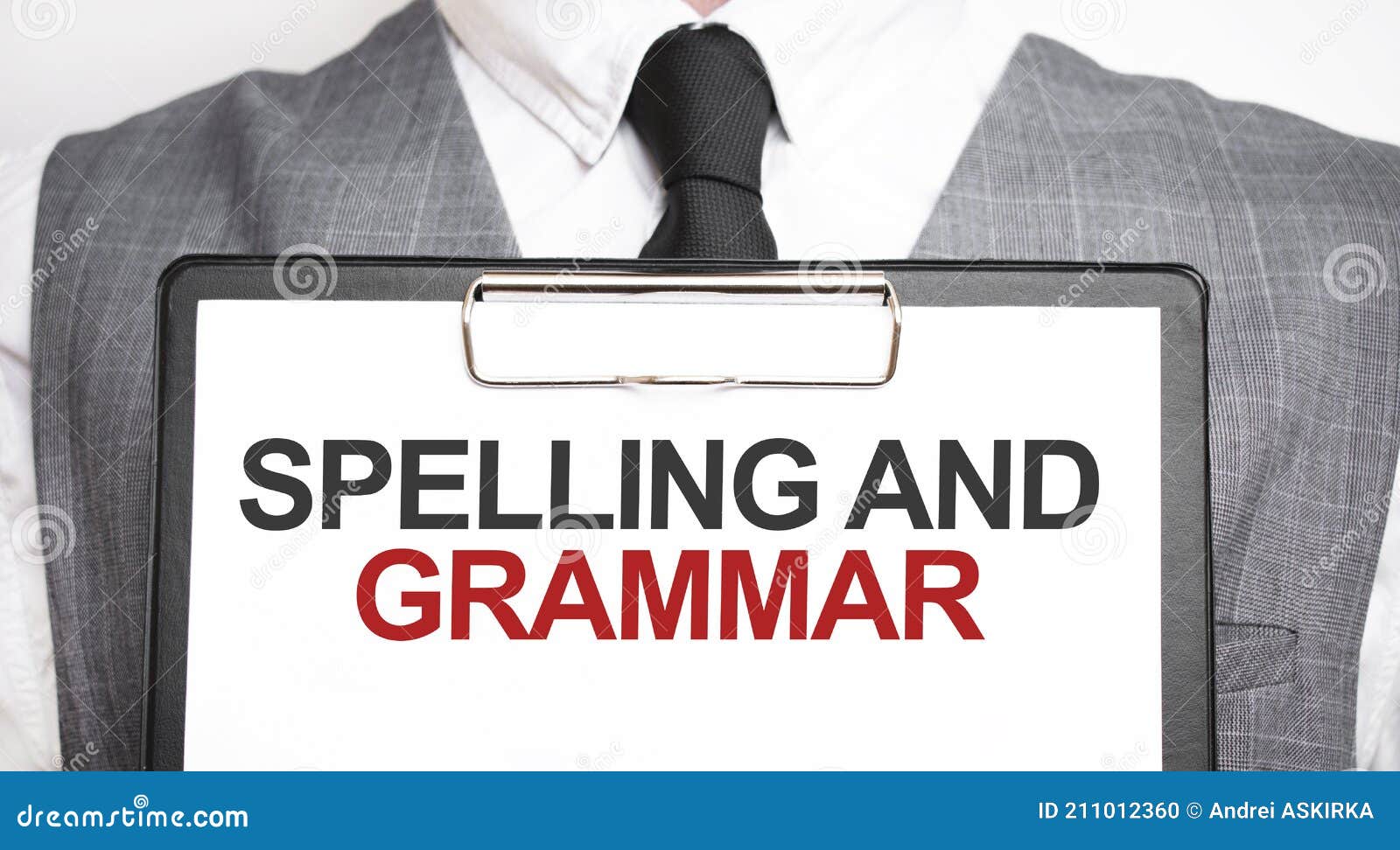 Businessman Holding Sheet of Paper with a Message Spelling and Grammar ...