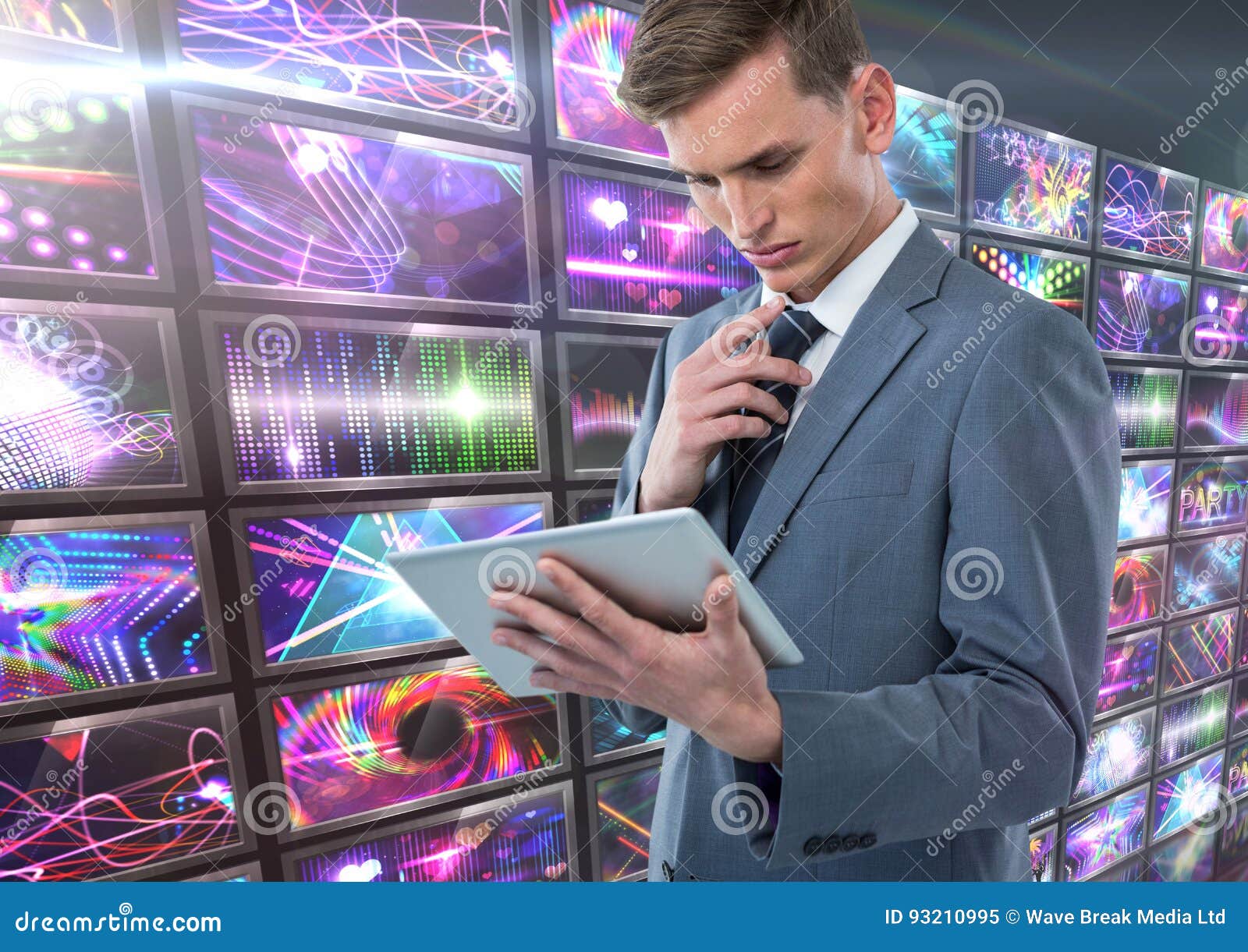 Businessman Holding Tablet with Colorful Screens Visuals Stock Image ...
