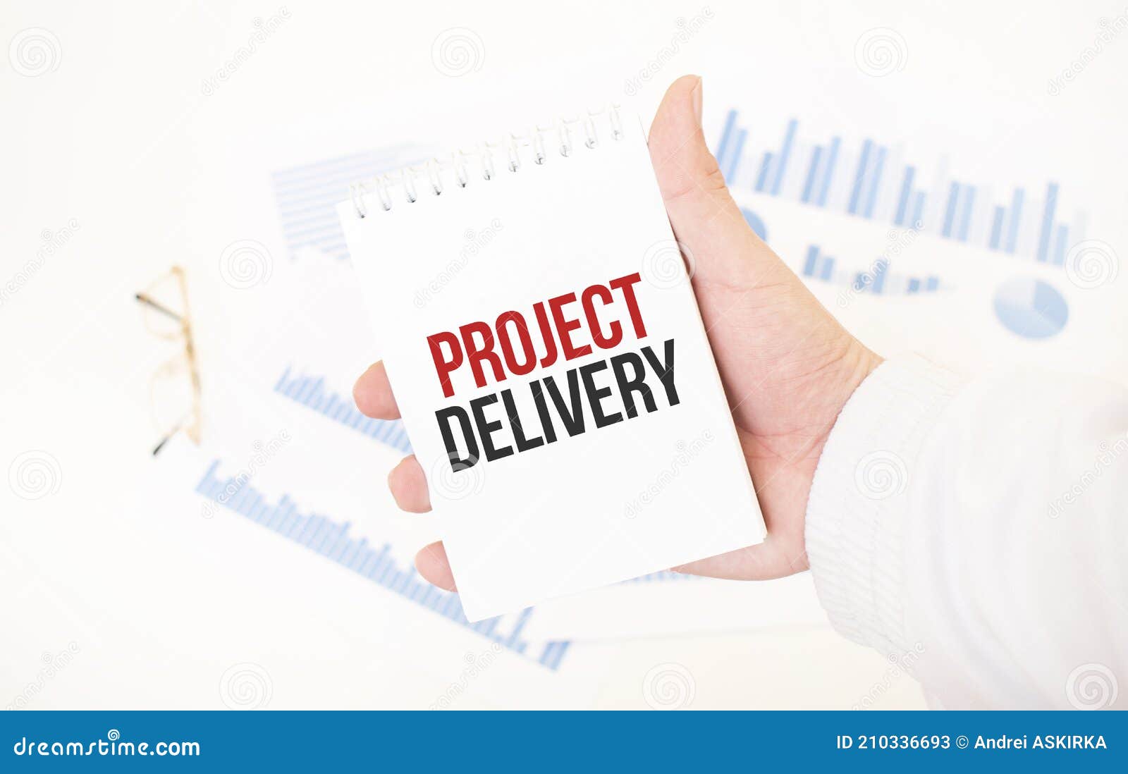 Businessman Holding a White Notepad with Text PROJECT DELIVERY ...