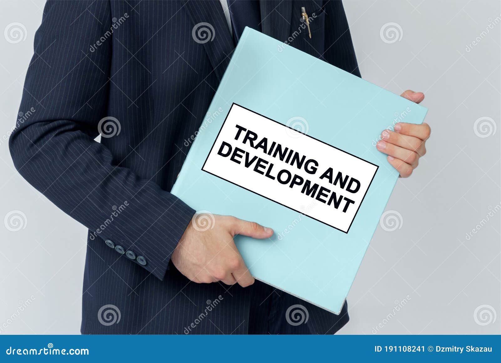 A Businessman Holds a Folder with Documents, the Text on the Folder is ...