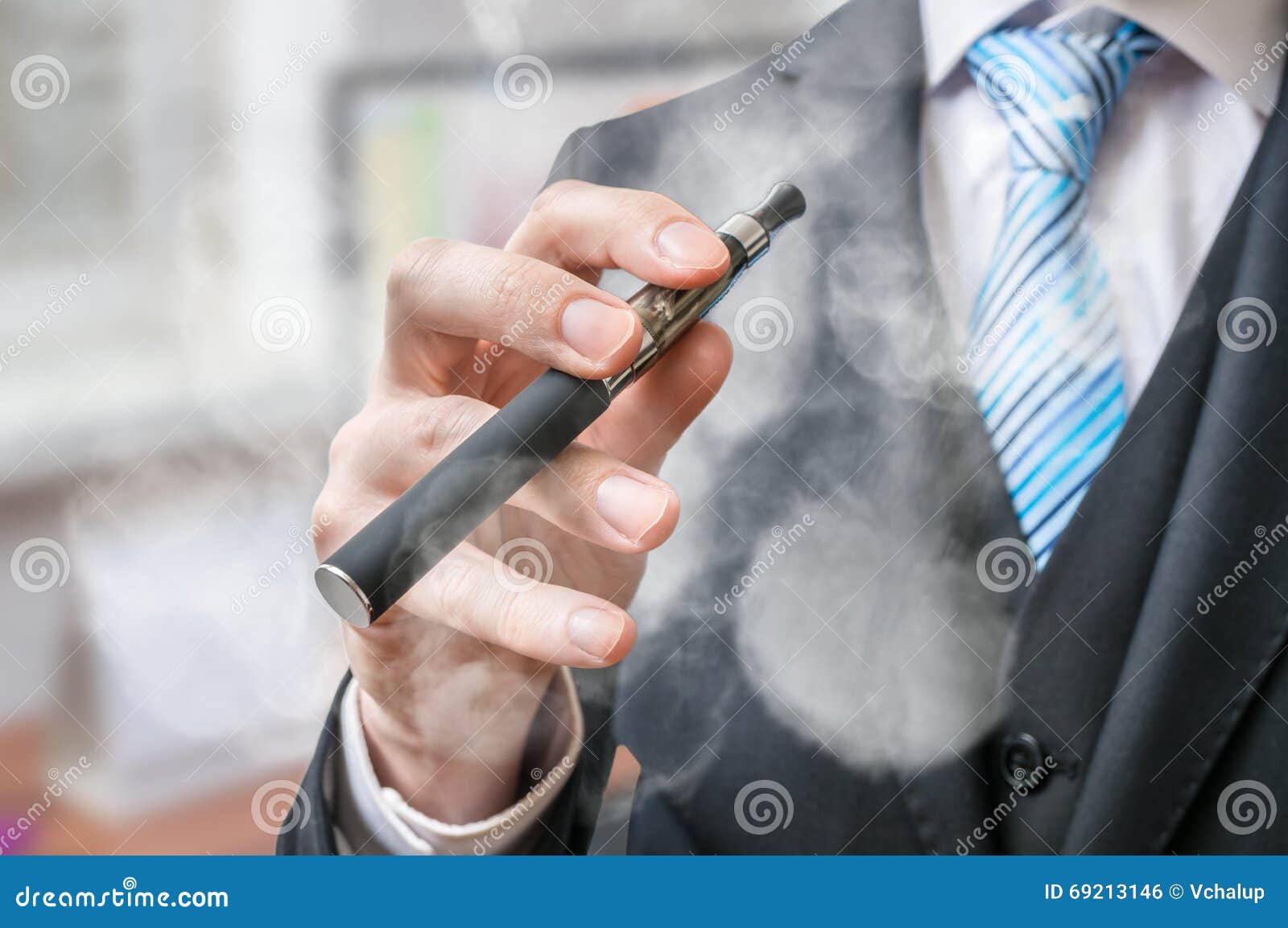 Businessman Holds Vaporizer and is Smoking Electronic Cigarette Stock ...