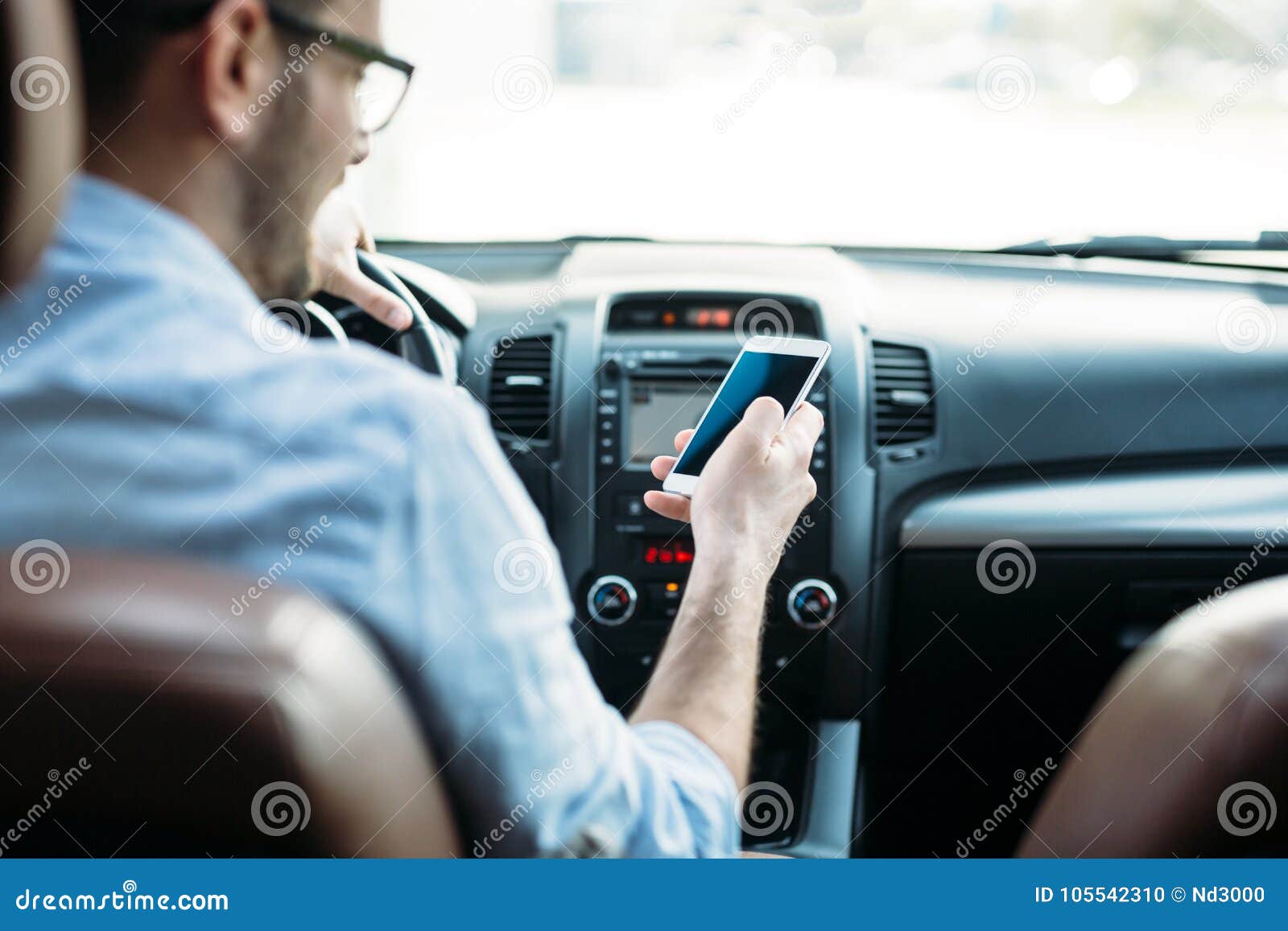 Businessman Ignoring Safety and Texting on Mobile Phone while Driving ... Businessman Ignoring Safety and Texting on Mobile Phone while Driving ...