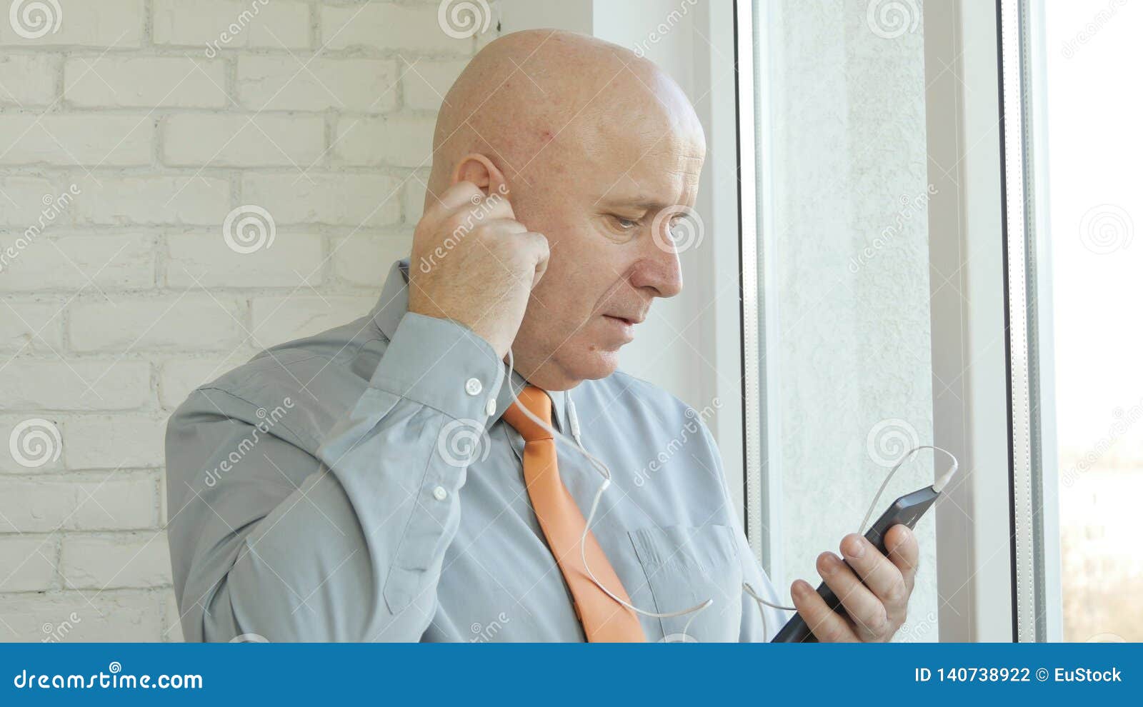 Businessman Use Headphones and Smartphone Accessing Online ...