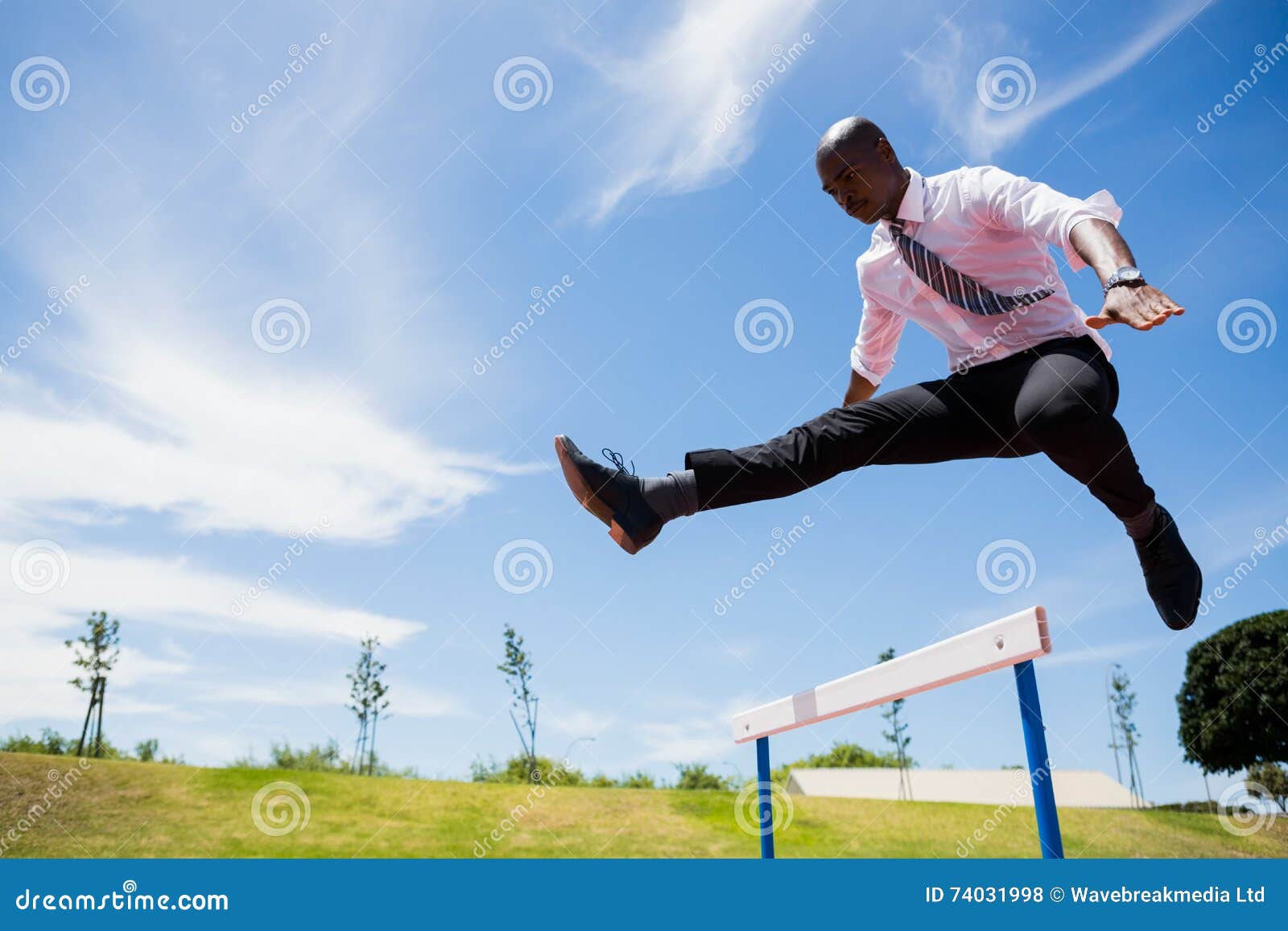 Businessman Jumping a Hurdle while Running Stock Photo - Image of ...