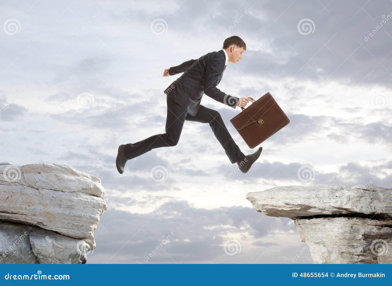 Businessman Jumping Over Rocks Stock Photo - Image of freedom, excited ...