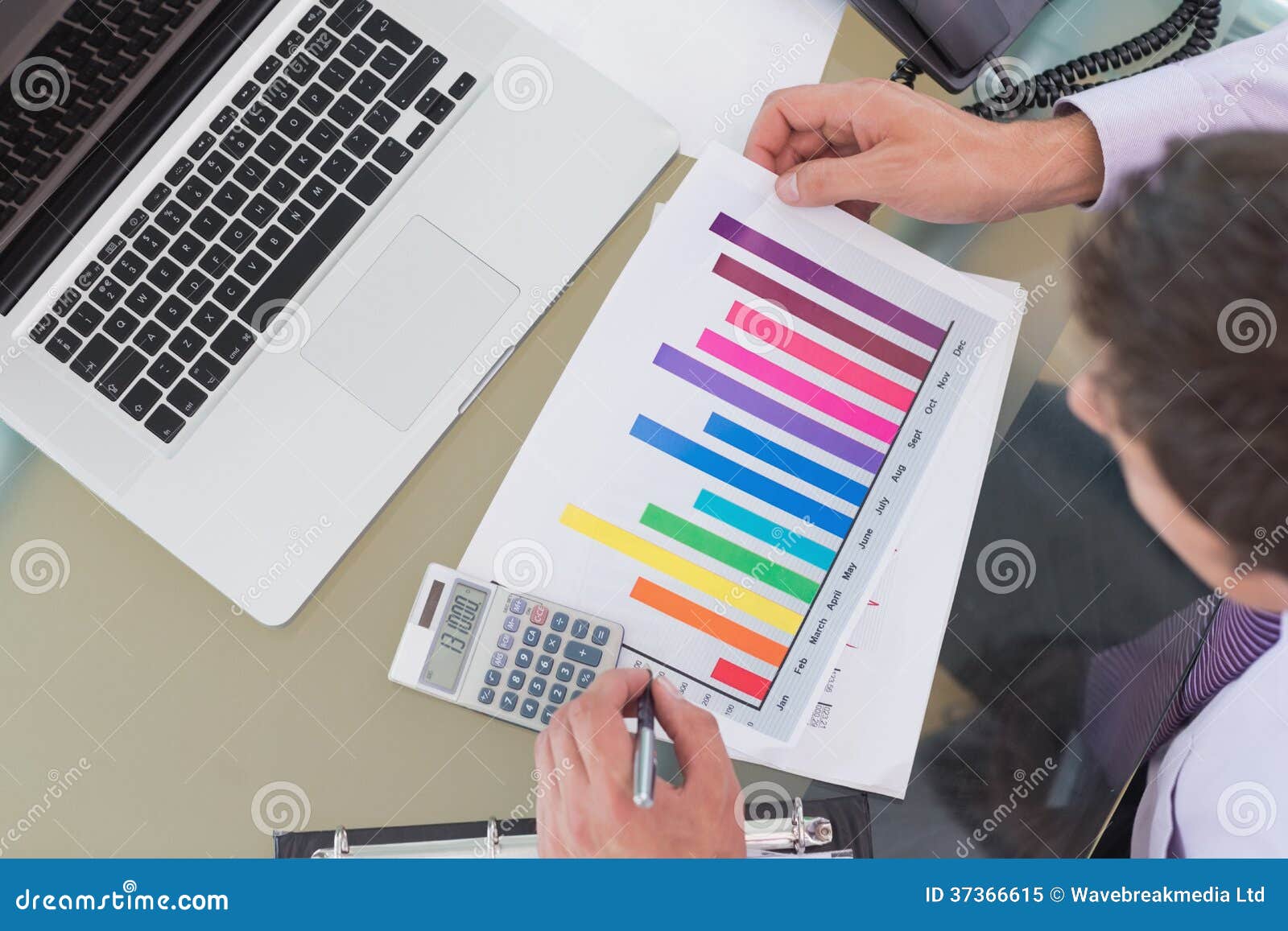 Businessman with Laptop and Graph at Office Desk Stock Image - Image of ...
