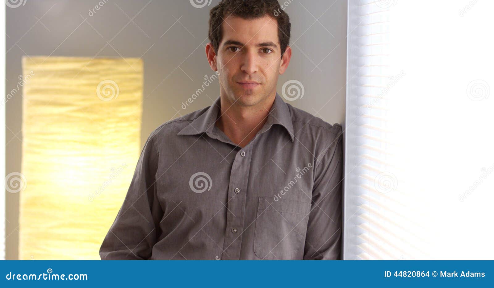 Businessman Leaning Against Wall Looking at Camera Stock Photo - Image ...