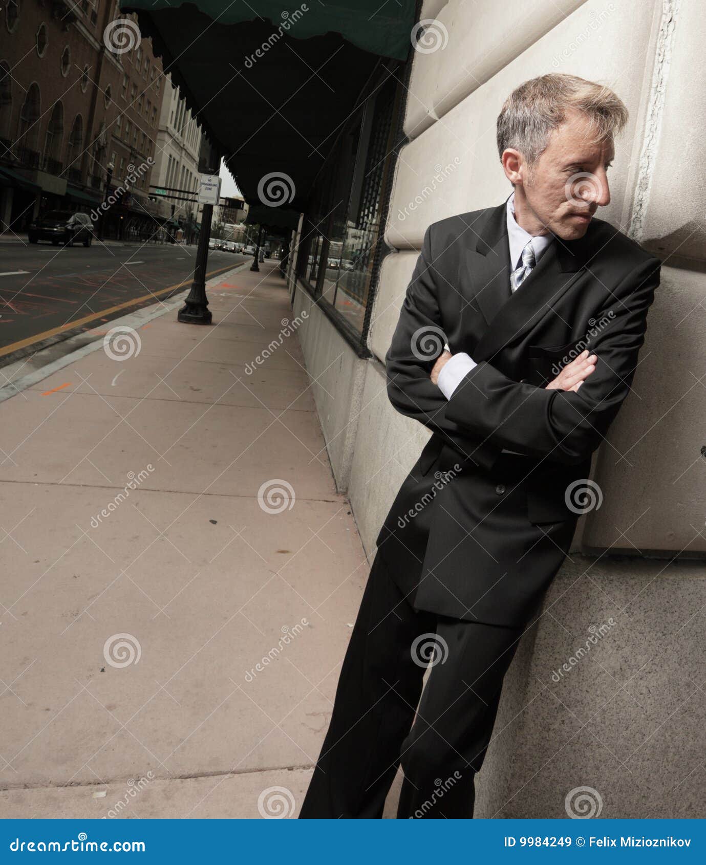 Businessman Leaning on a Building Stock Image - Image of glance, flash ...
