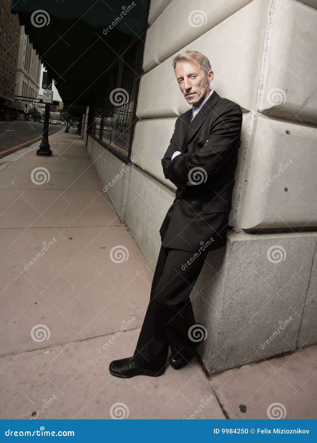 Businessman Leaning on a Building Stock Photo - Image of city ...