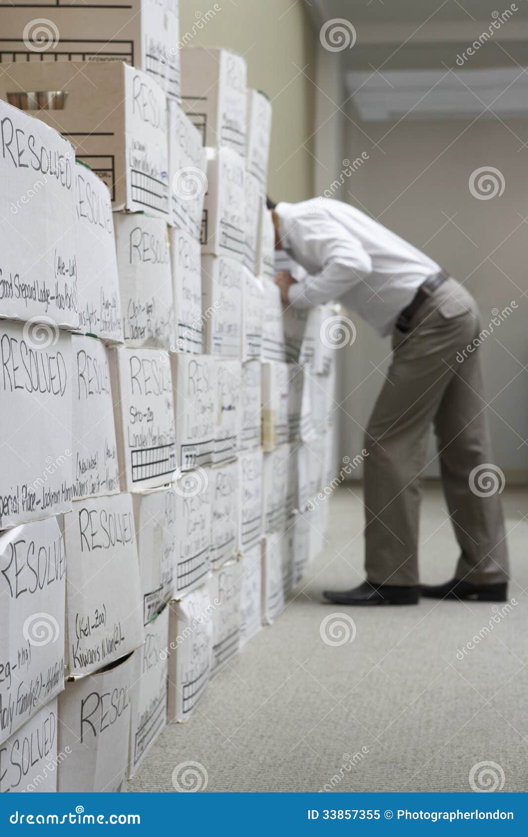 Businessman Leaning Over Boxes in Storage Room Stock Image - Image of ...