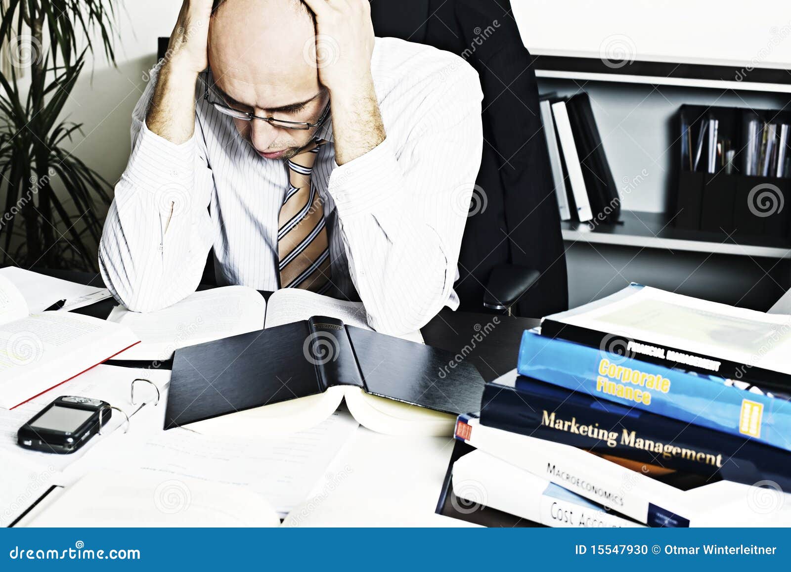 Businessman Leaning Over Office Desk Studying Stock Photo - Image of ...
