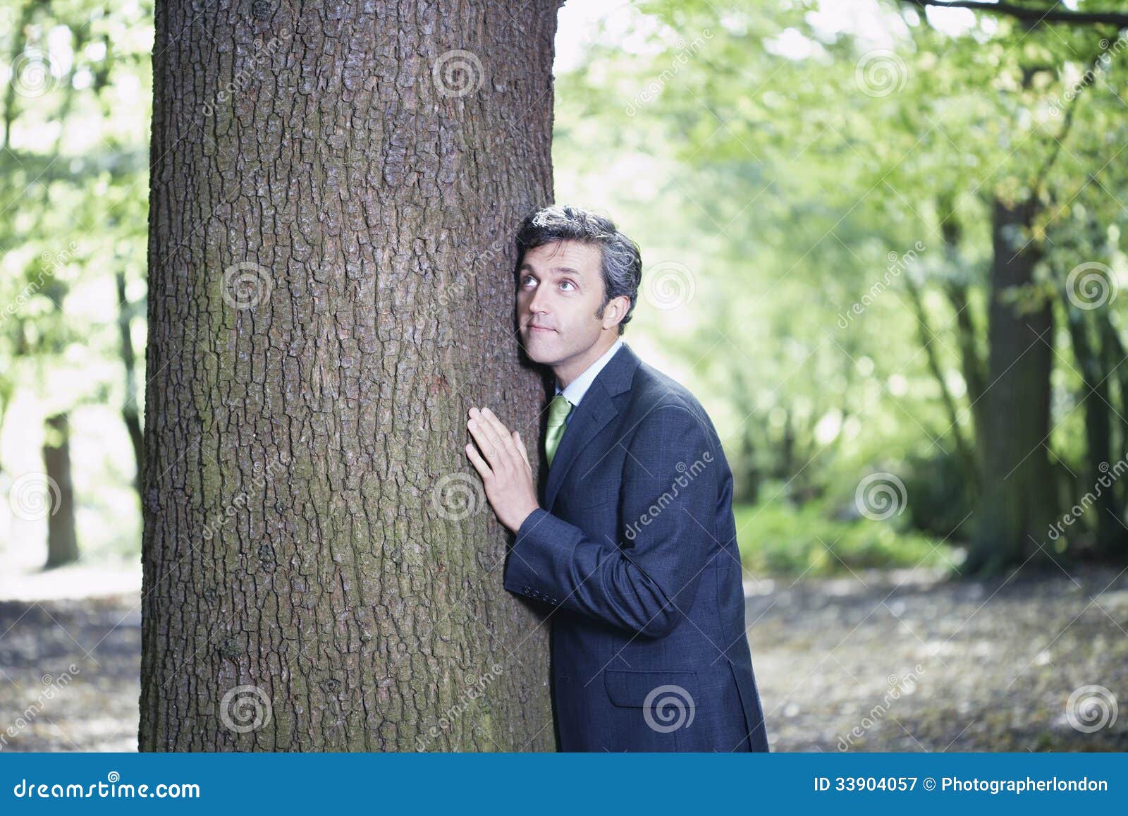 Businessman Leaning on Tree Trunk in Forest Stock Image - Image of ...