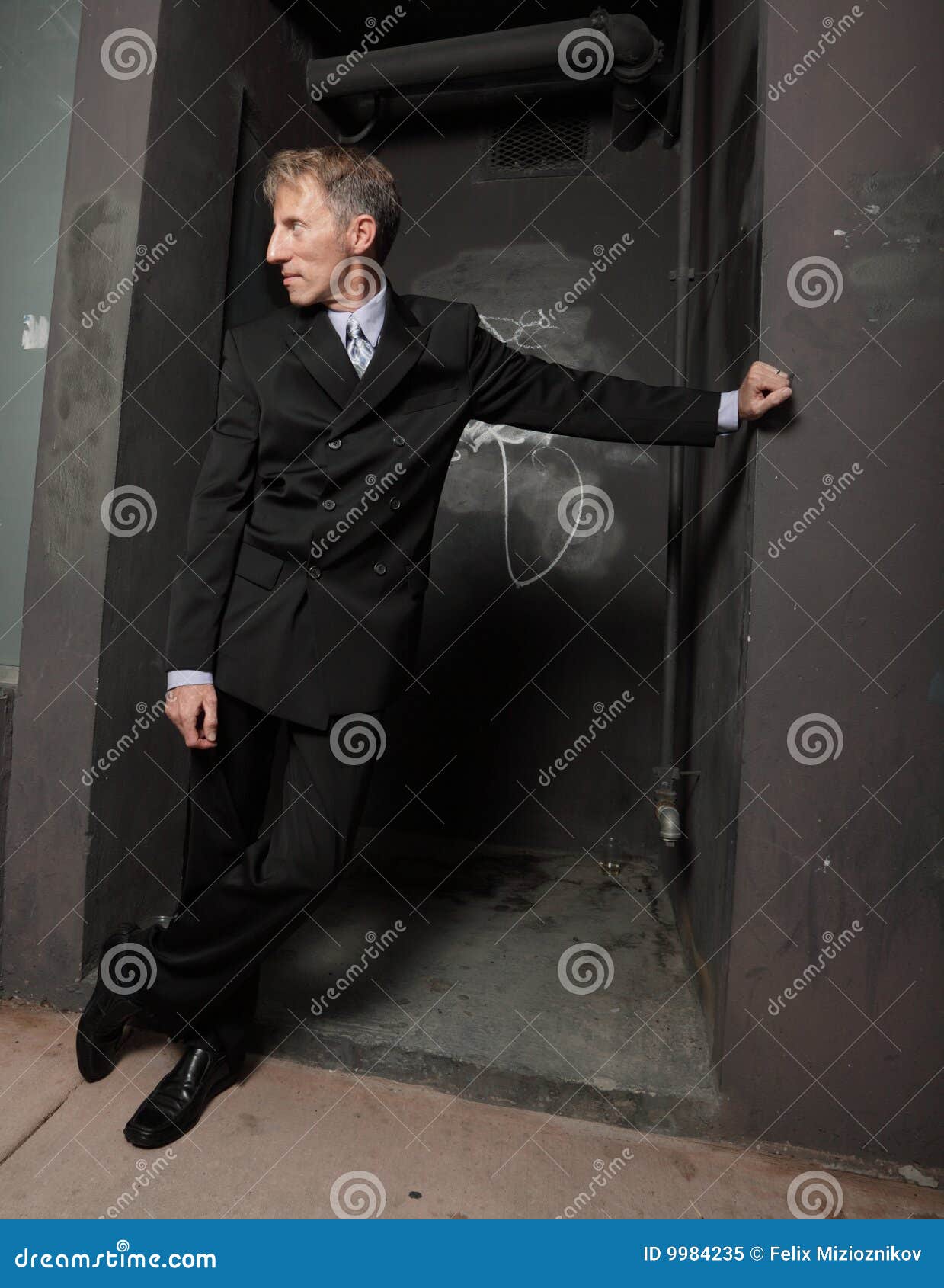 Businessman Leaning on a Wall at Night Stock Image - Image of grungy ...
