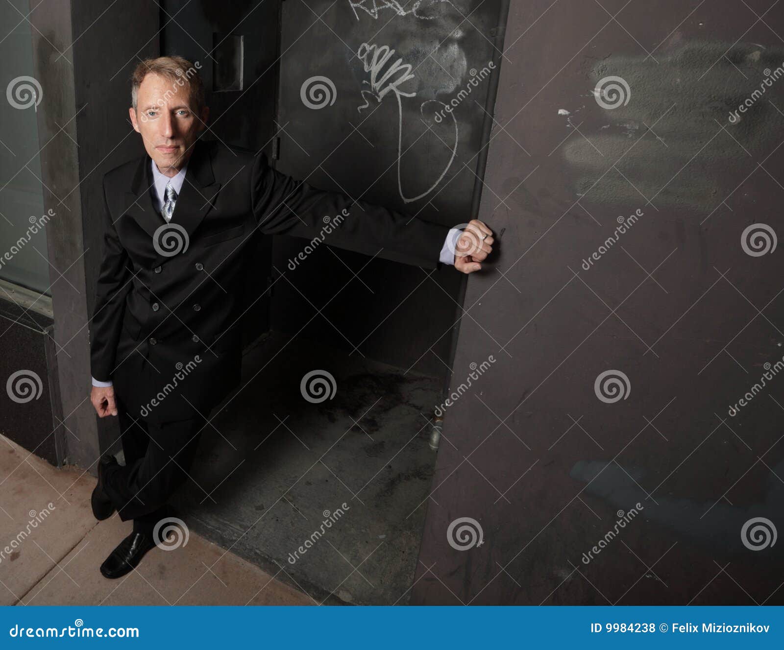 Businessman Leaning on a Wall at Night Stock Photo - Image of wall ...