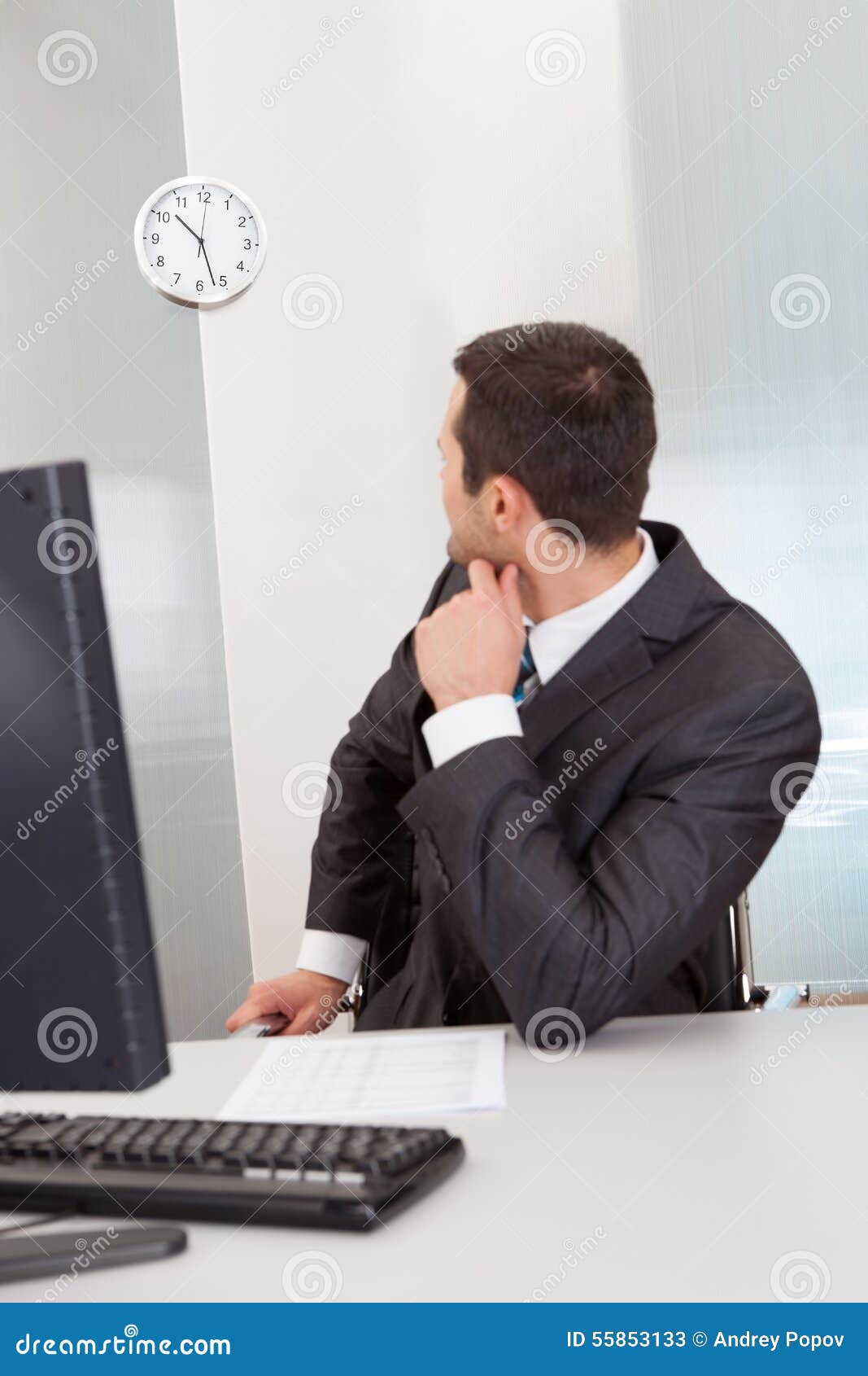 Businessman Looking at Clock at the Office Stock Image - Image of ...