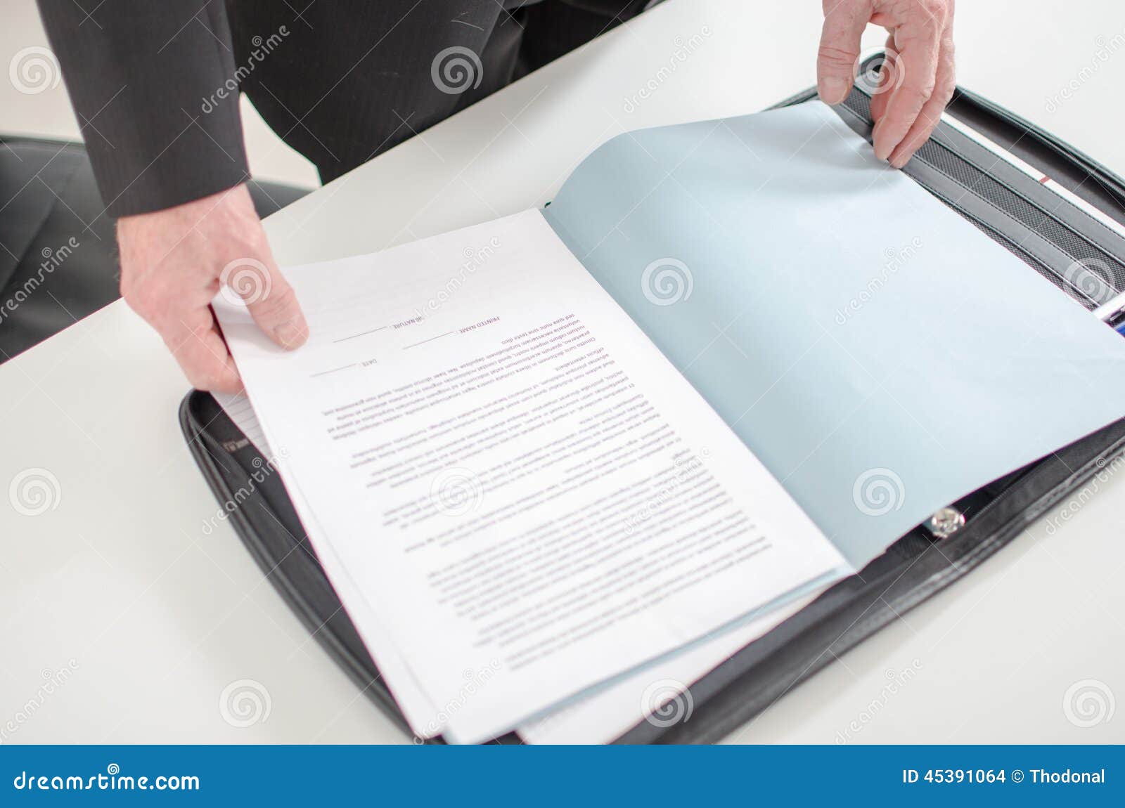 Businessman Looking at a Document Stock Photo - Image of papers ...