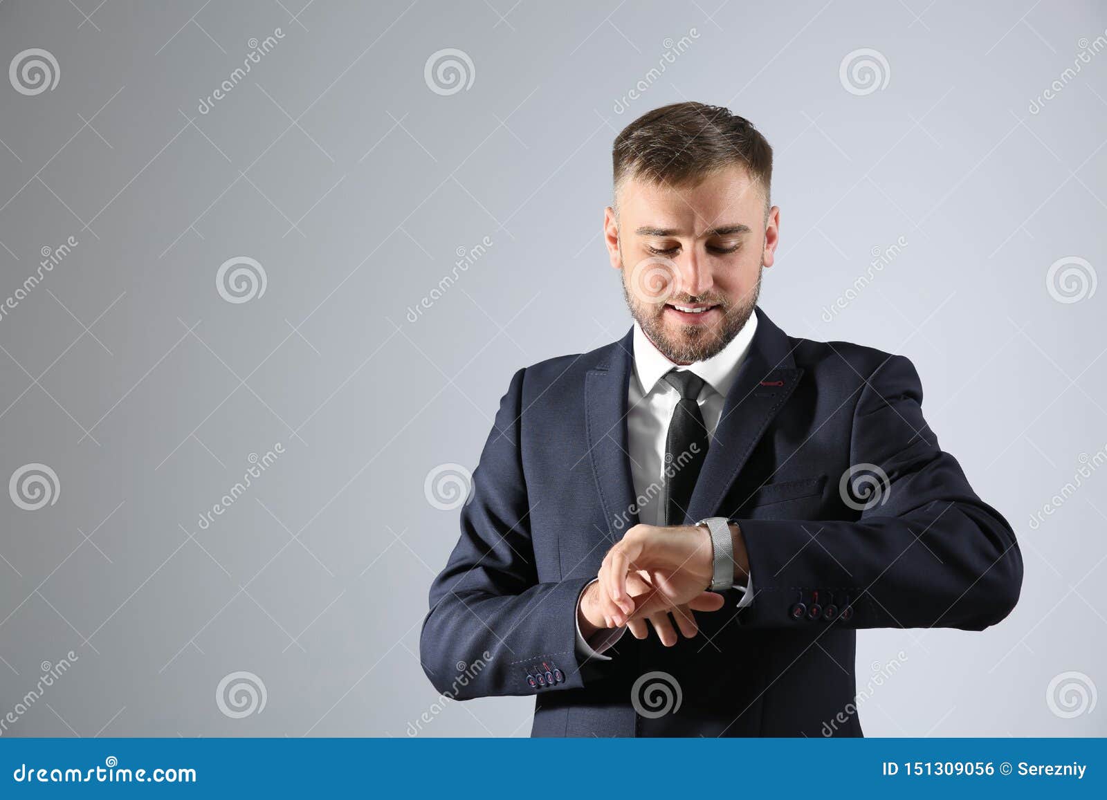 Businessman Looking at His Watch on Light Background Stock Photo ...