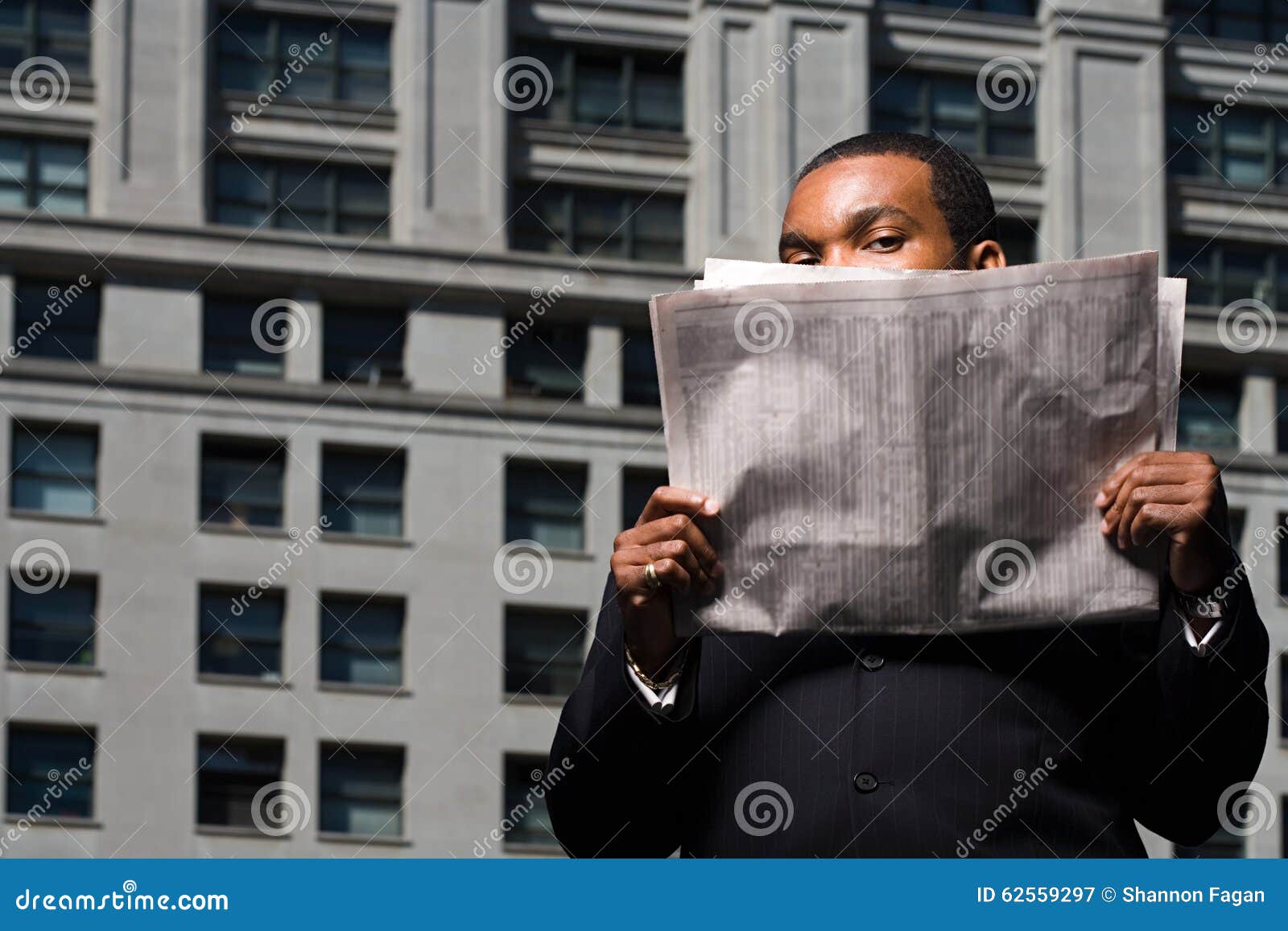 Businessman Looking Over Newspaper Stock Image - Image of holding ...