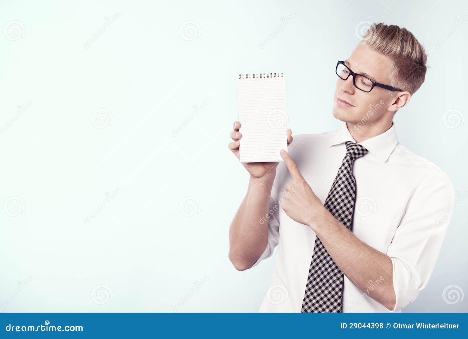 Businessman Looking and Pointing Finger at Empty Notepad. Stock Photo ...