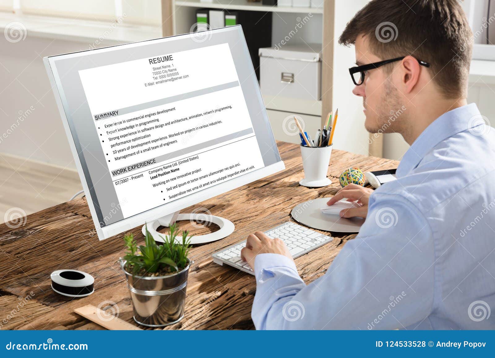 Businessman Looking at Resume on Computer Stock Photo - Image of ...