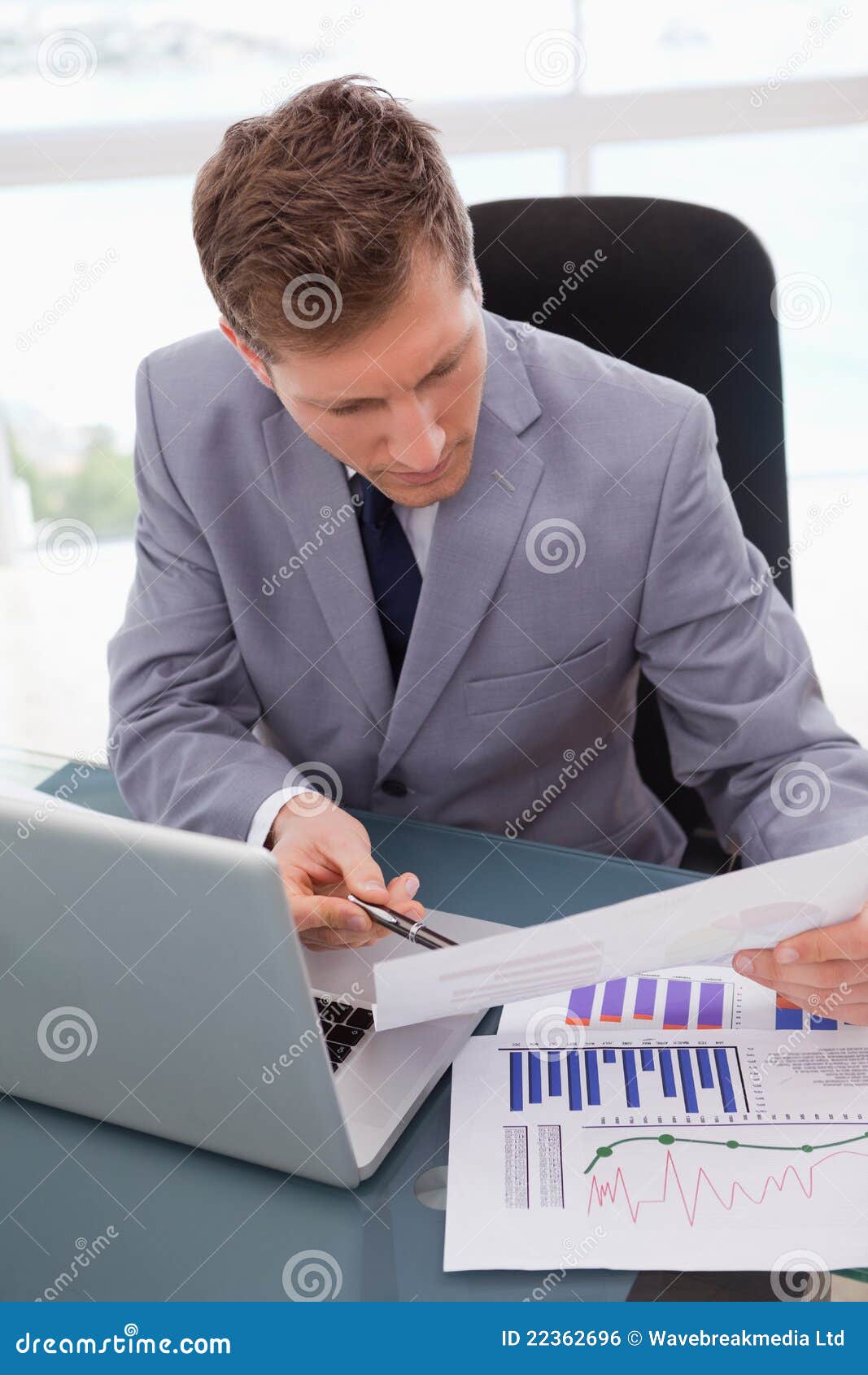 Businessman Looking at Statistics Stock Photo - Image of typing ...