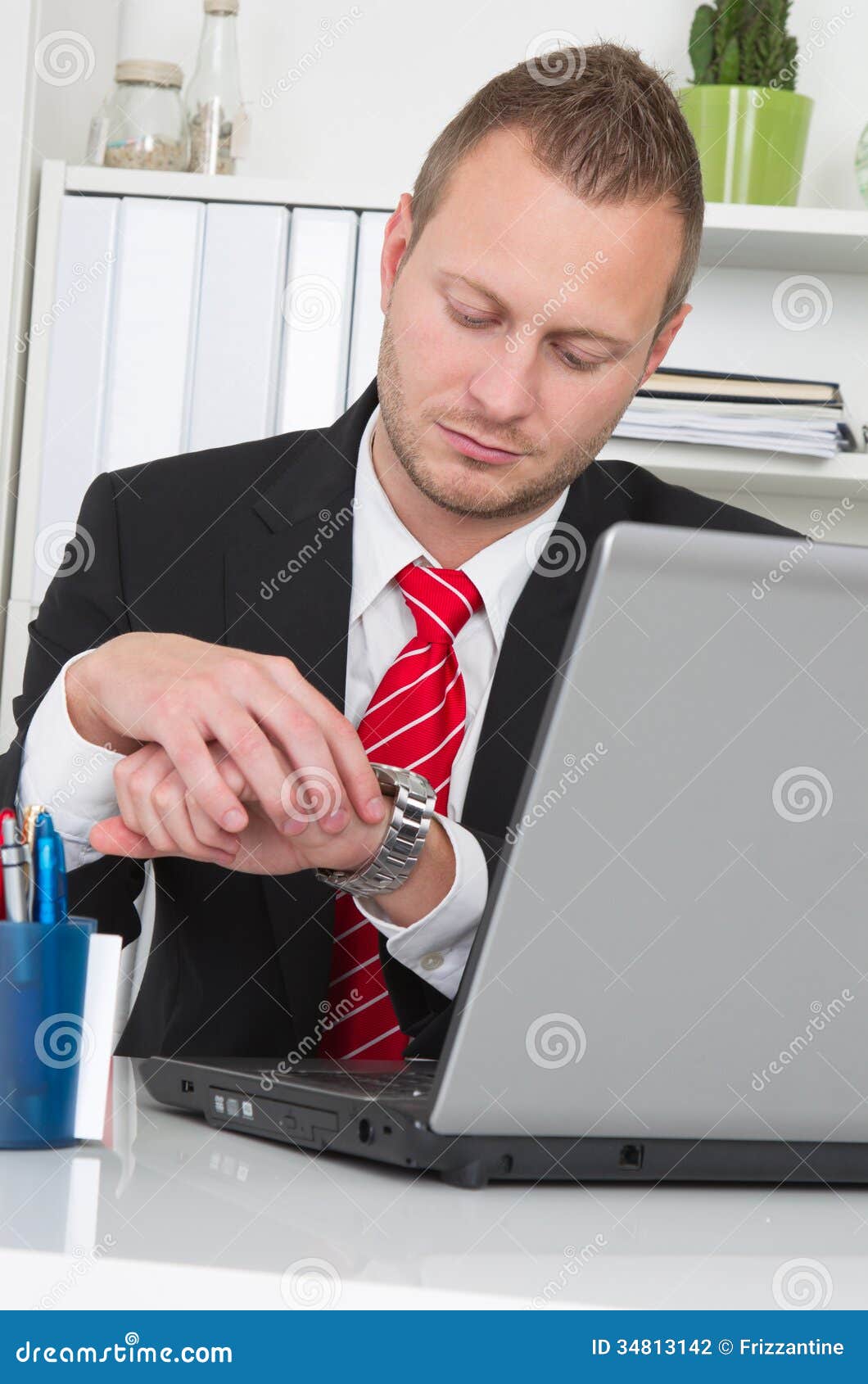 Businessman Looking at Watch with Laptop - End of Work Stock Photo ...