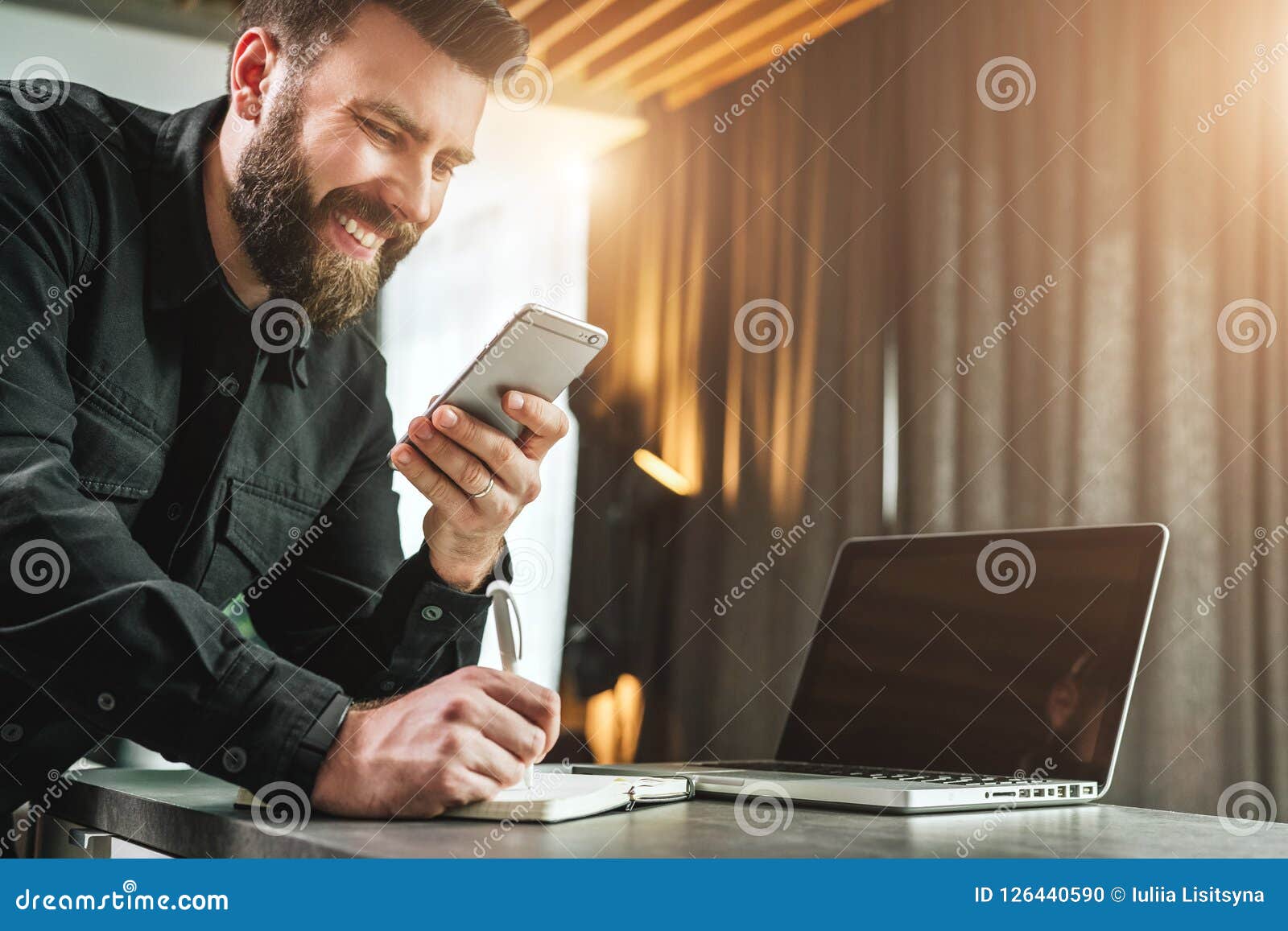 Businessman is Standing Near Computer, Working on Laptop, Making Notes ...