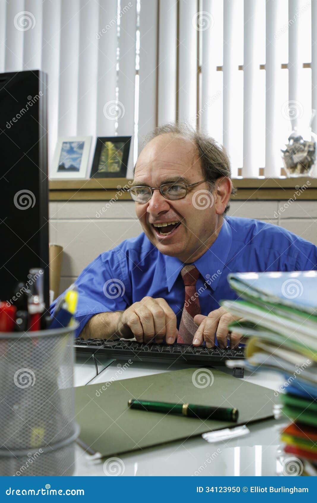 Businessman Manically Laughing at Desk Looking at Computer in Office ...